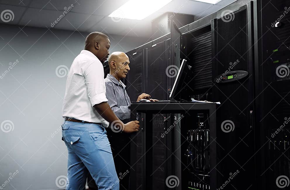 Having a Healthy Server is Integral To Business. Two it Technicians Using a Computer while ...