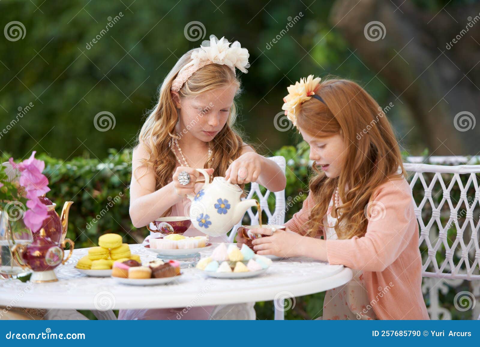 Having a Make-believe Tea Party. Two Young Girls Having a Tea Party in ...