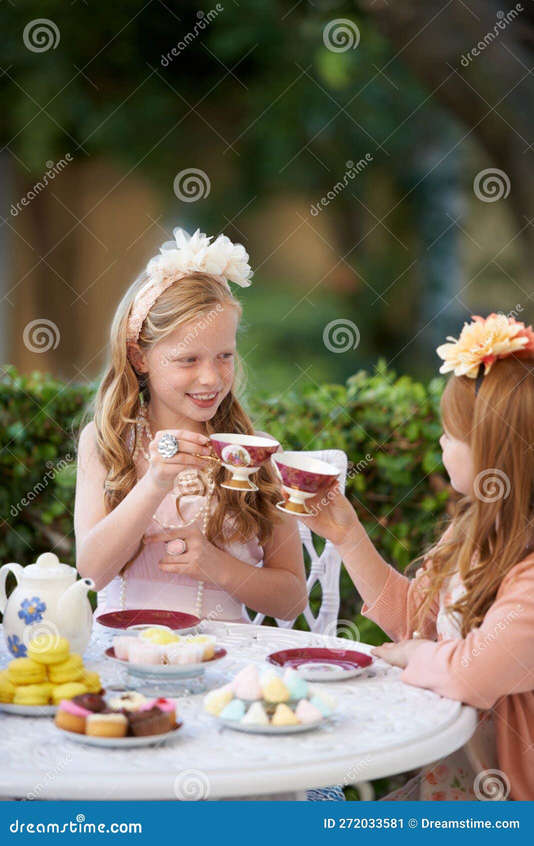Having a Make-believe Tea Party. Two Young Girls Having a Tea Party in ...