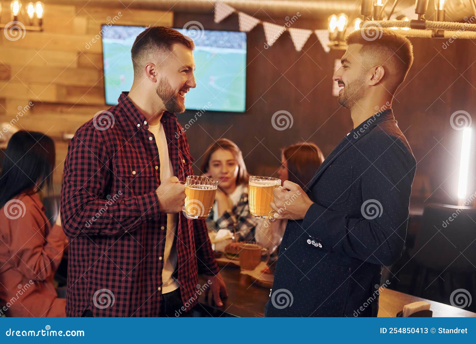 Having a Rest. Group of Young Friends Sitting Together in Bar with Beer ...