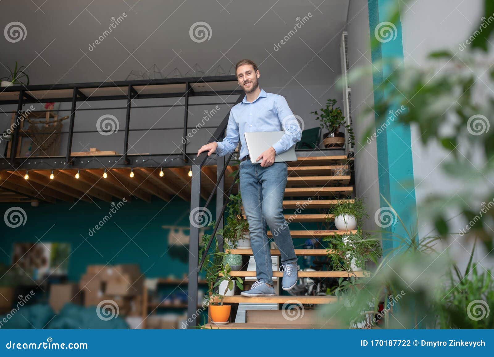 Man Standing on Stairs Holding His Computer Stock Photo - Image of ...