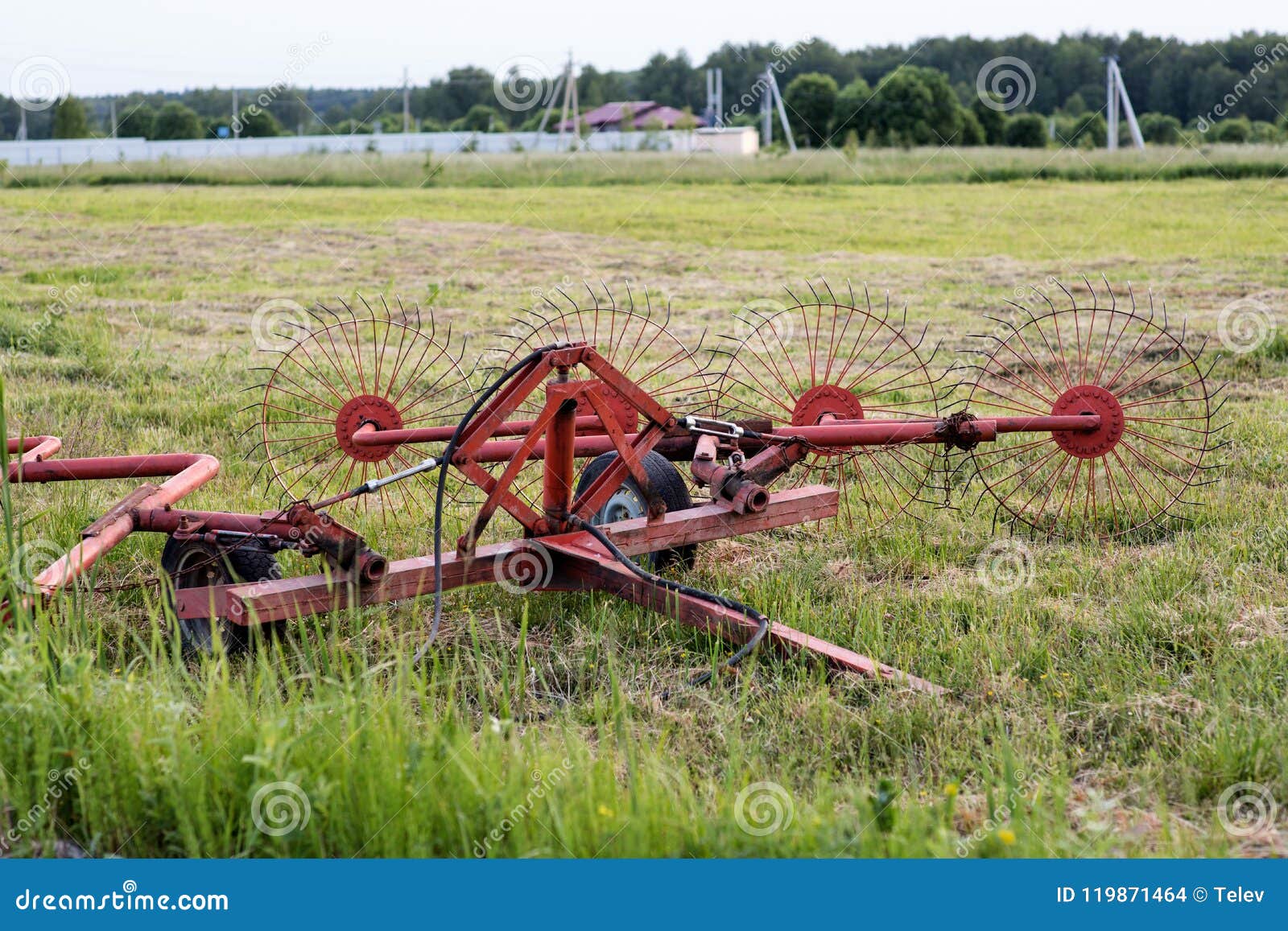 Hay tedder on the field stock photo. Image of harvest - 119871464