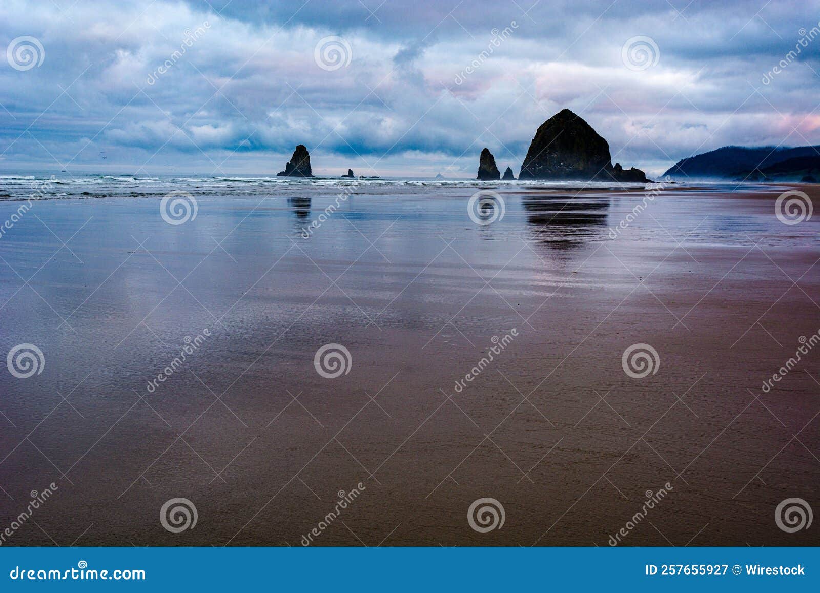 Haystack Rock on Cannon Beach Under Cloudy Dusk Sky, Oregon Stock Image ...