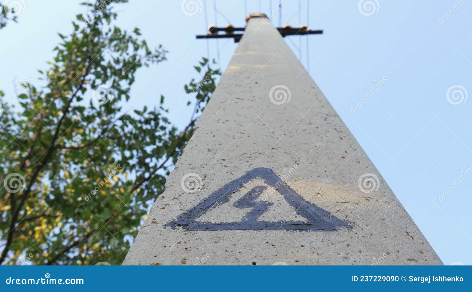A Hazard Sign on a Concrete Pillar. Electrical Support for Hanging ...