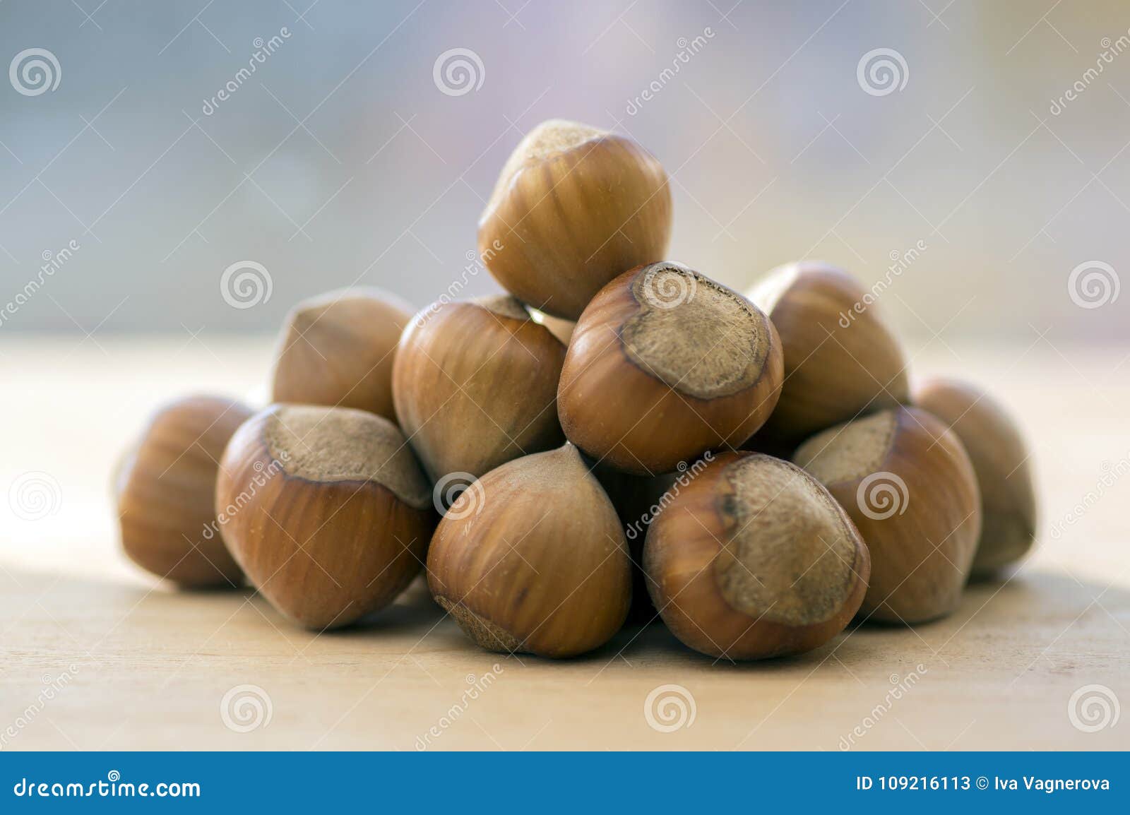 Hazel Nuts in Hard Shells, Pile on Wooden Table Stock Image - Image of ...