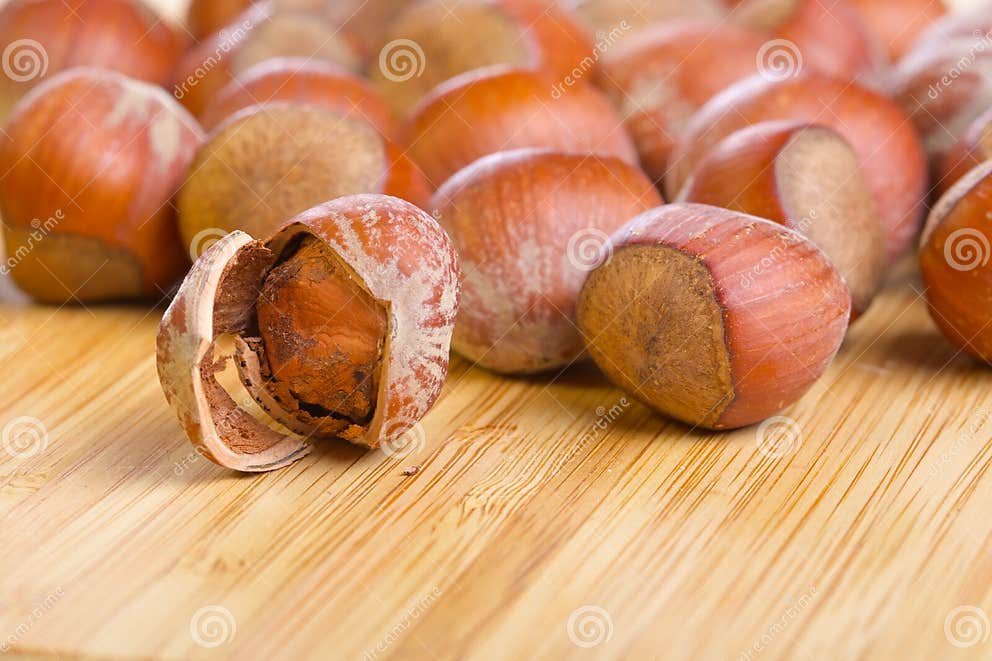 Hazelnut Kernel Inside Shell on Wooden Background Stock Photo - Image ...