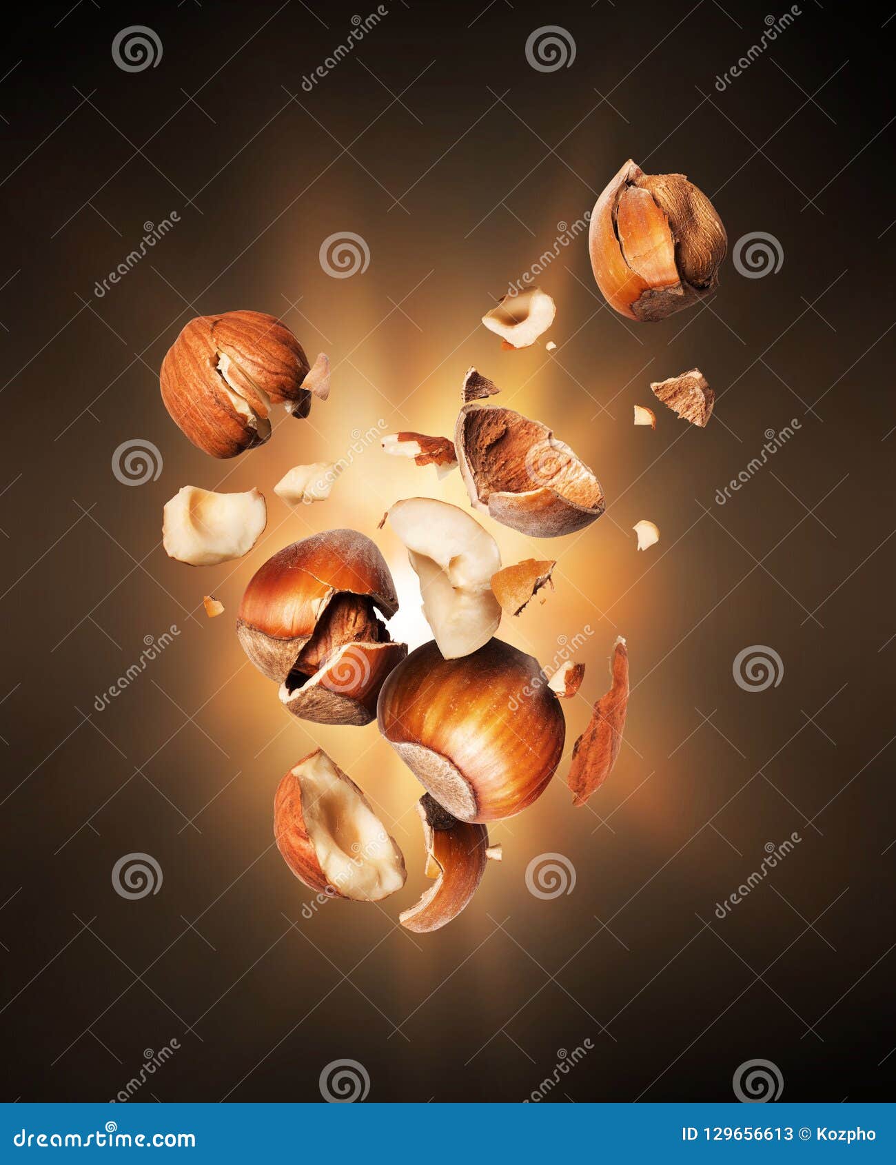 Hazelnuts Crushed Into Pieces, Frozen In The Air On A White Royalty ...