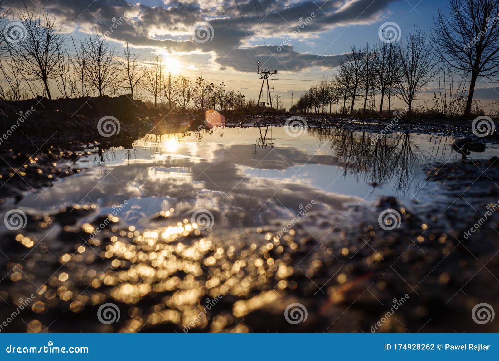 HDR Photo of the Setting Sun Reflecting in a Puddle. Stock Photo ...