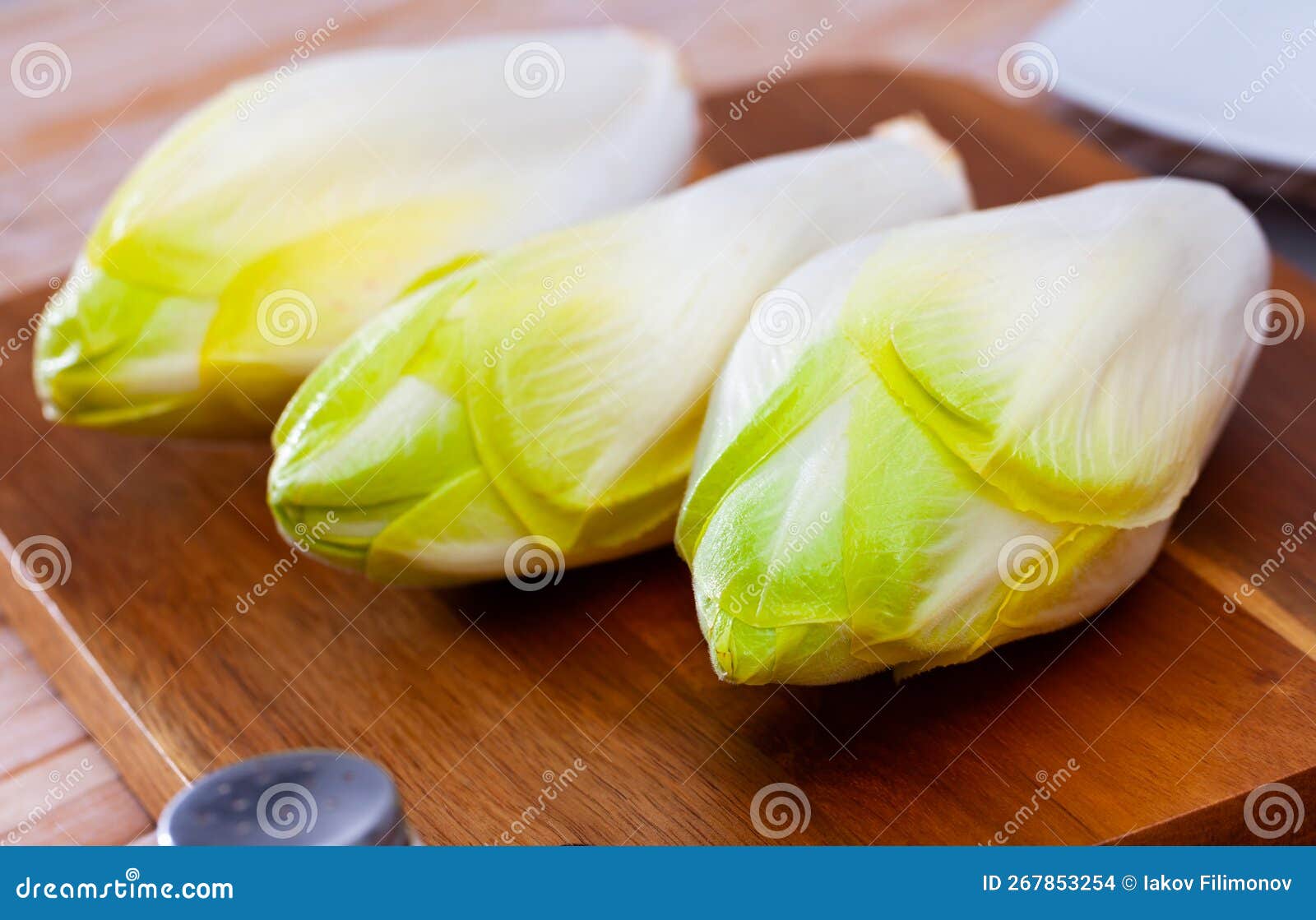 Head of Belgian Endive Chicory on Wooden Table Stock Photo - Image of ...