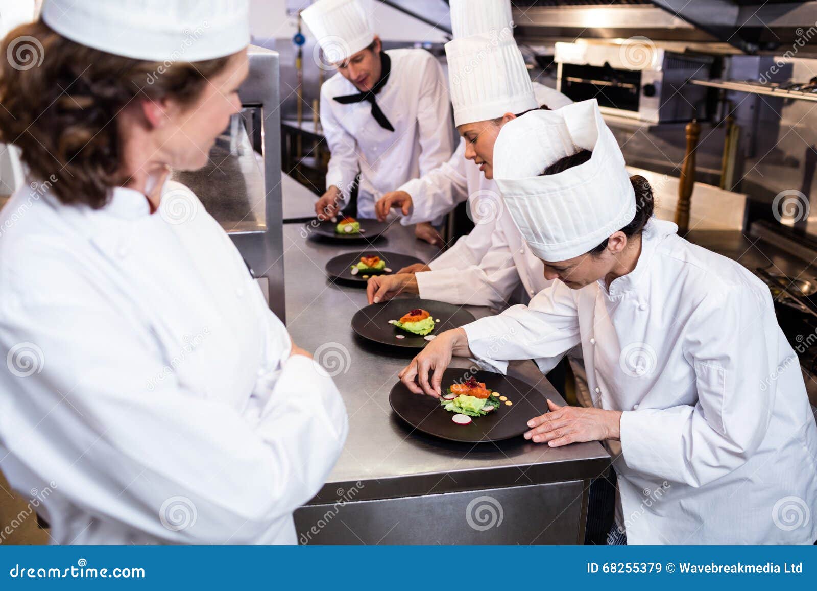 Head Chef Overlooking Other Chef Decorating Dish Stock Image - Image of ...