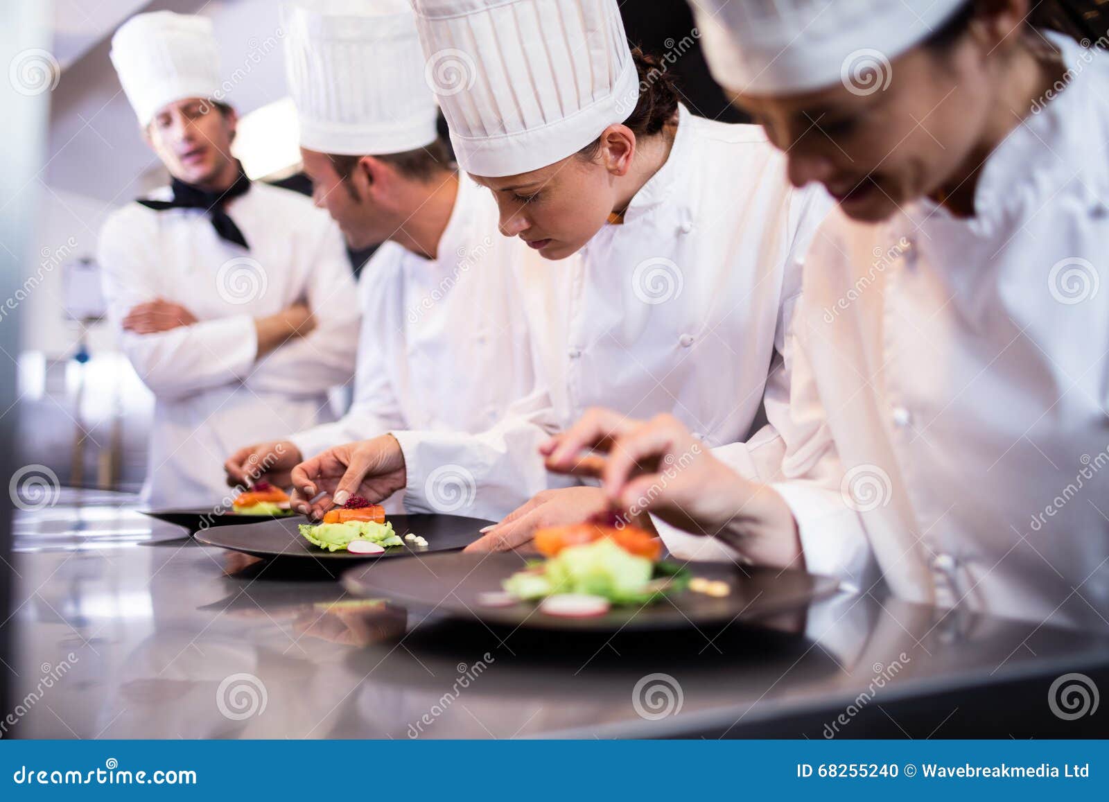 Head Chef Overlooking Other Chef Preparing Dish Stock Photo - Image of ...