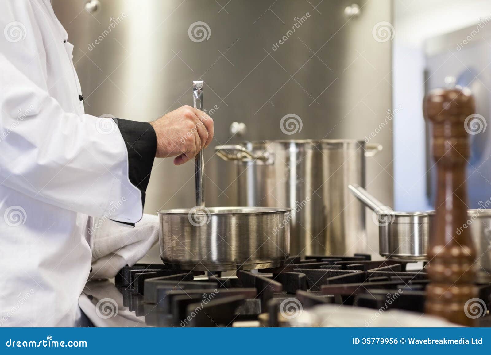 Head chef stirring in pot stock photo. Image of working - 35779956
