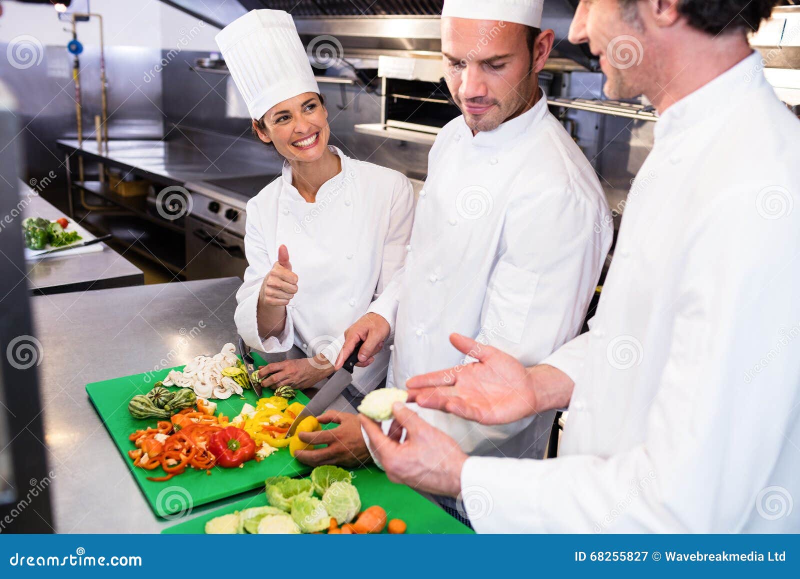 Head Chef Teaching His Colleagues How To Slice Vegetables Stock Image ...