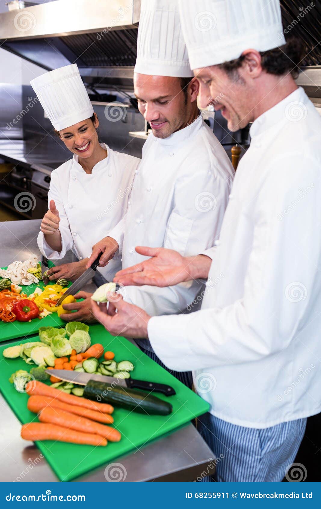 Head Chef Teaching His Colleagues How To Slice Vegetables Stock Image ...