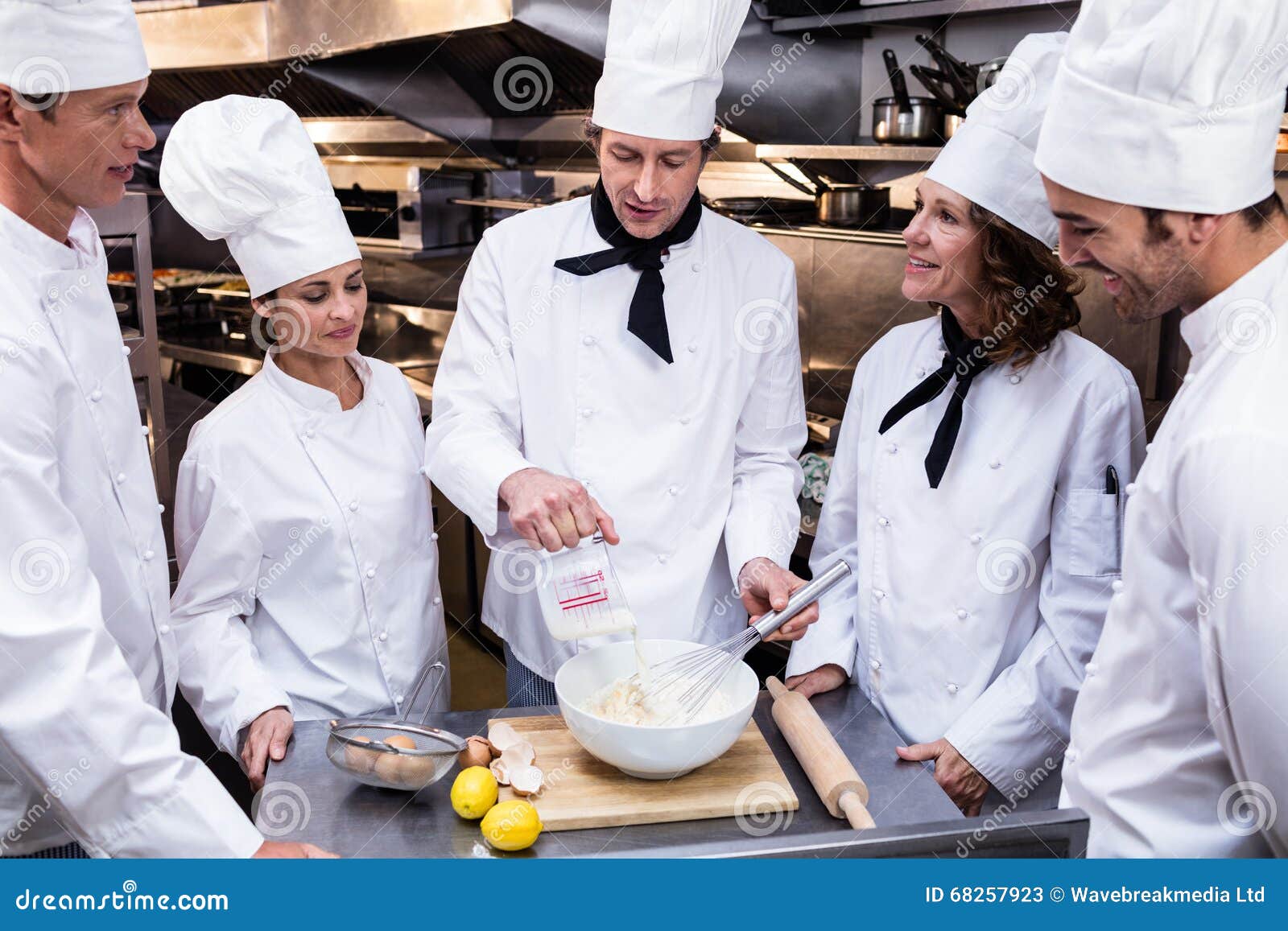 Head Chef Teaching His Team To Prepare a Dough Stock Image - Image of ...