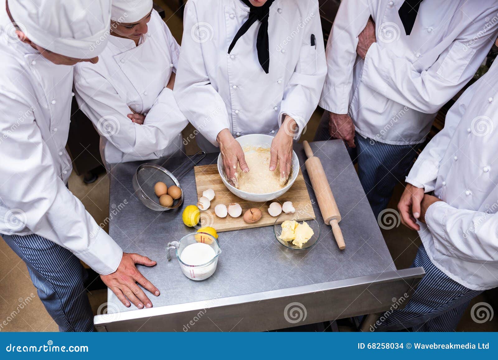 Head Chef Teaching His Team To Prepare a Dough Stock Photo - Image of ...
