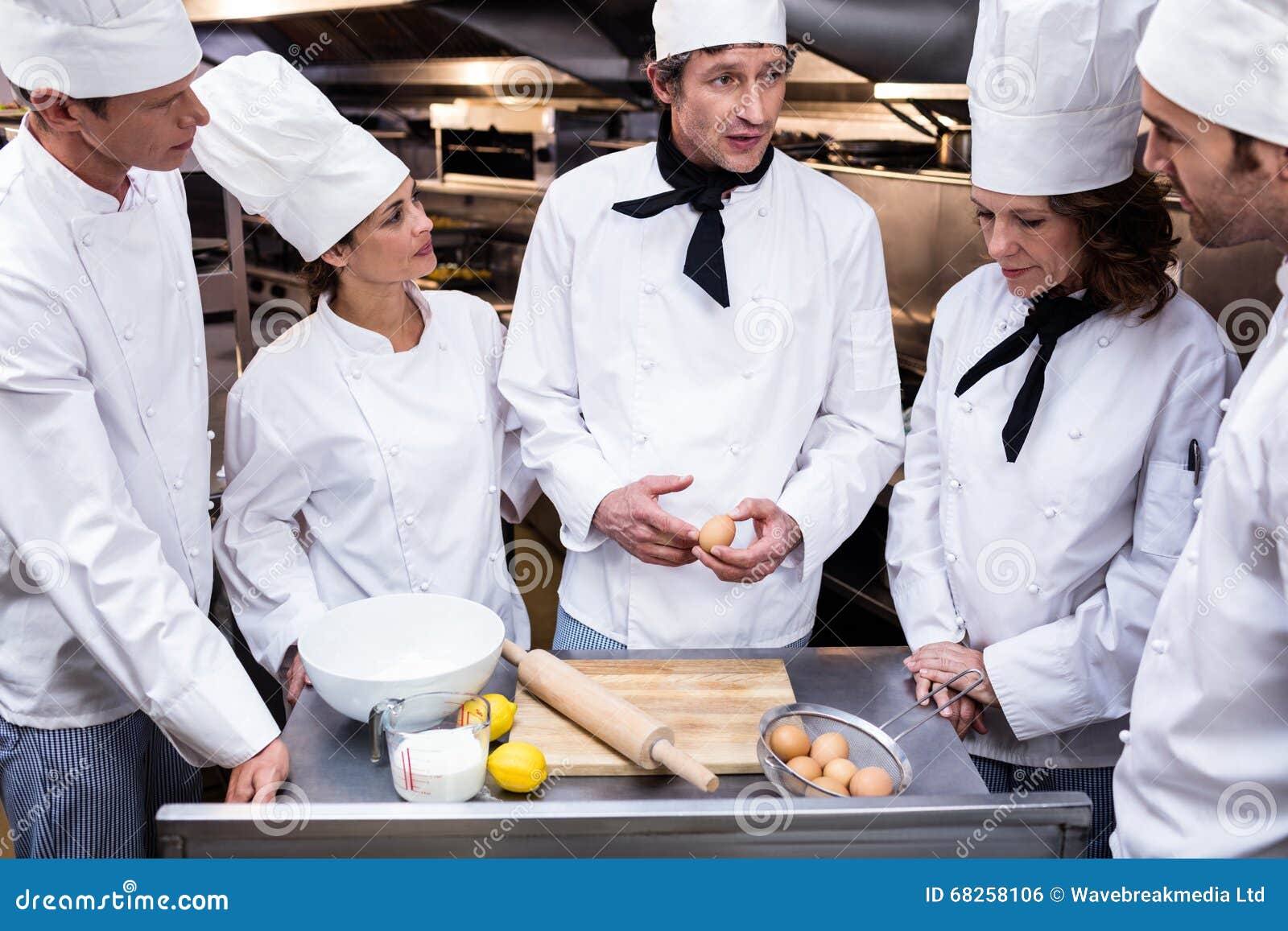 Head Chef Teaching His Team To Prepare a Dough Stock Photo - Image of ...