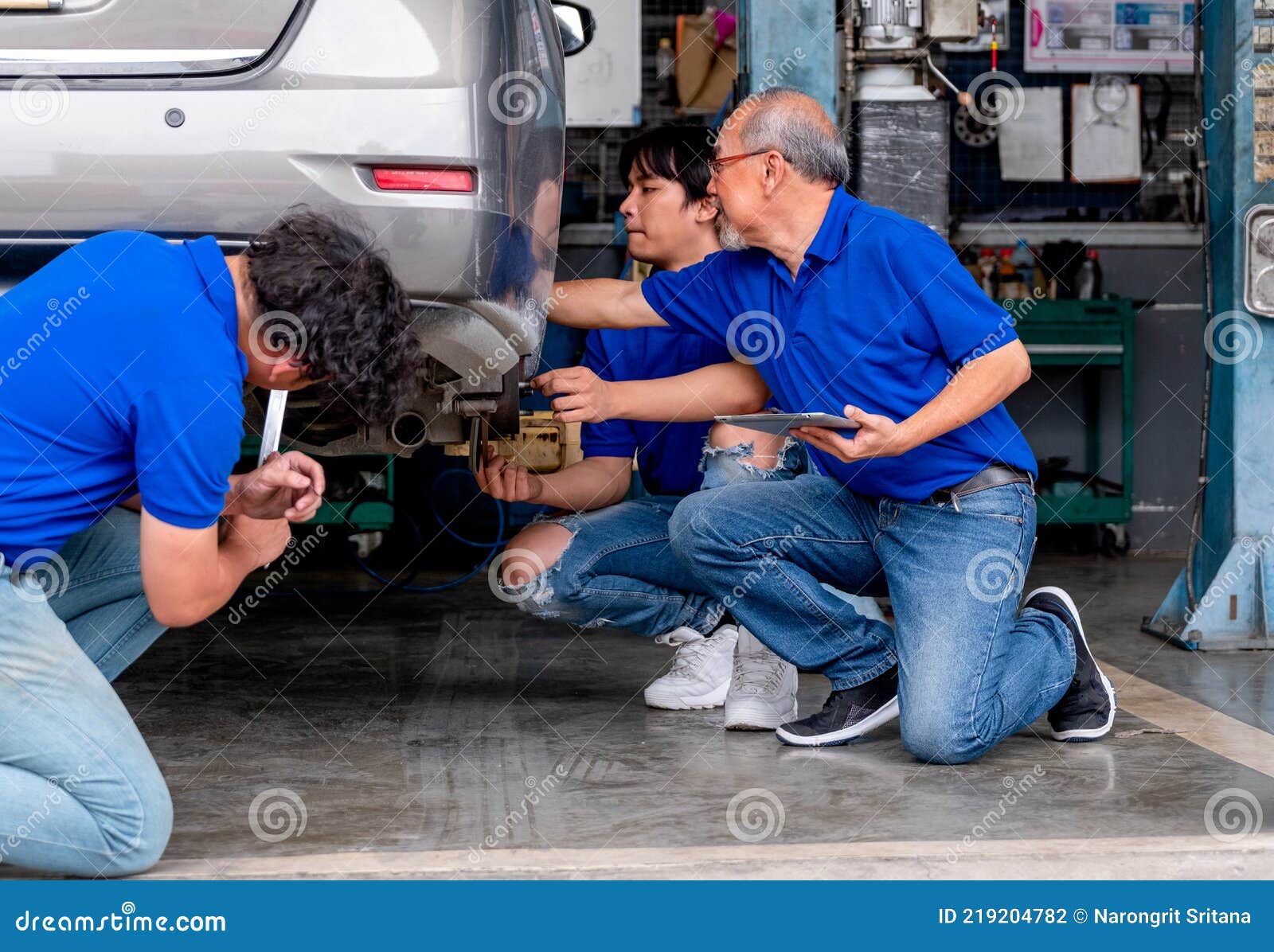 Head and Garage Workers Help To Fix the Problem of Car in Workplace ...