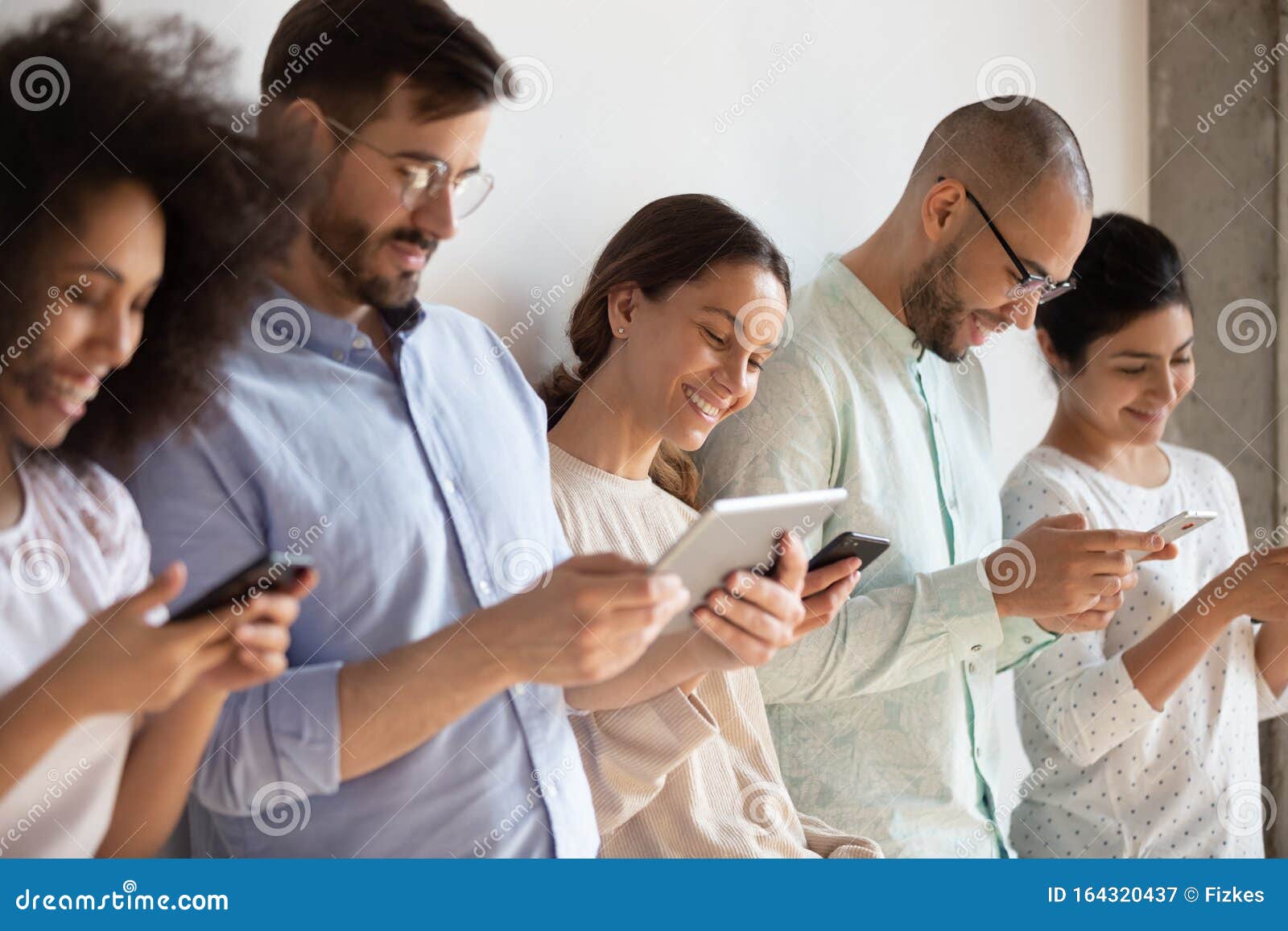 Addicted To Technology Group of Mixed Race Students Using Devices ...