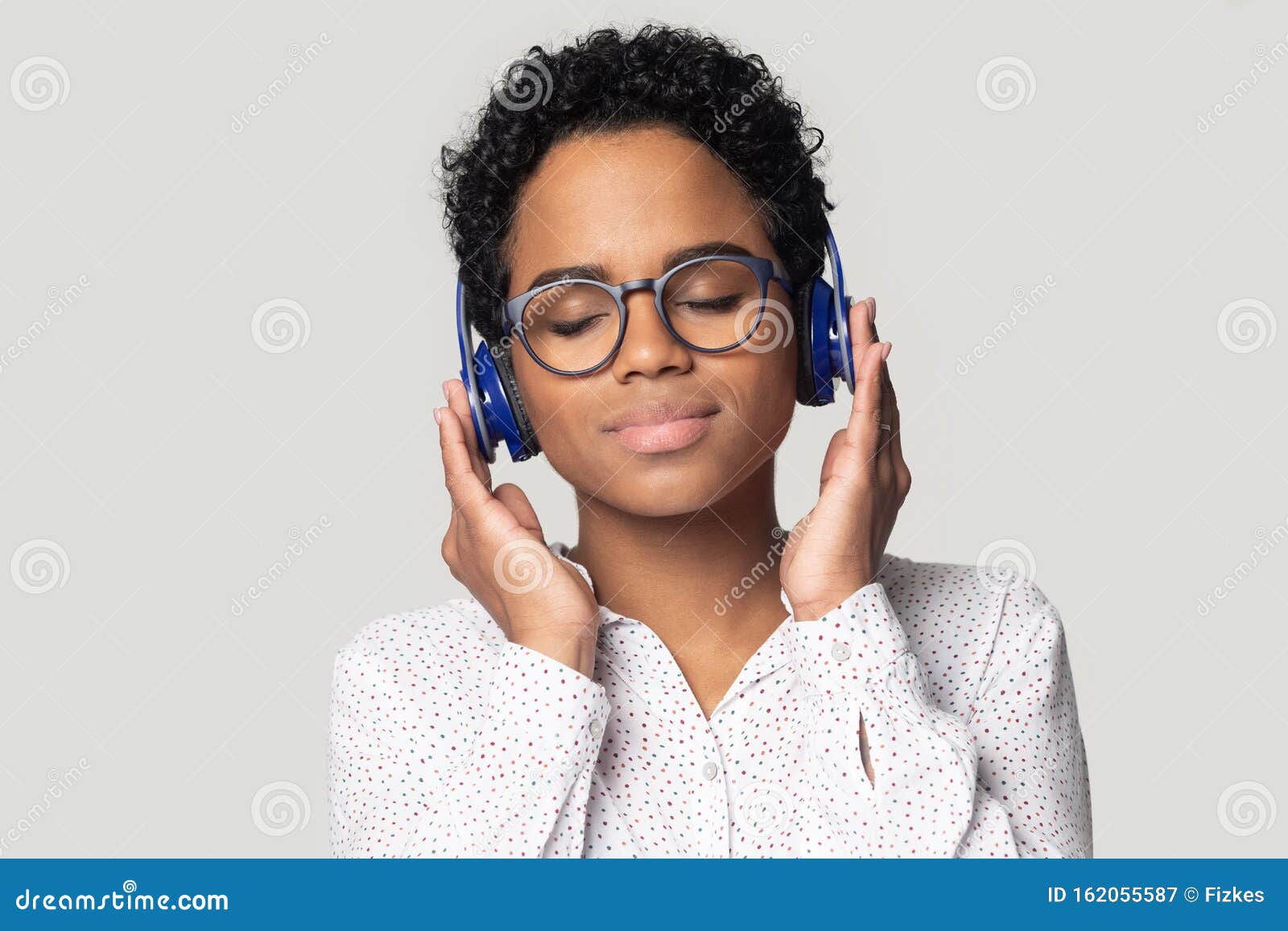 Head Shot Relaxed African American Woman In Headphones Enjoying Music