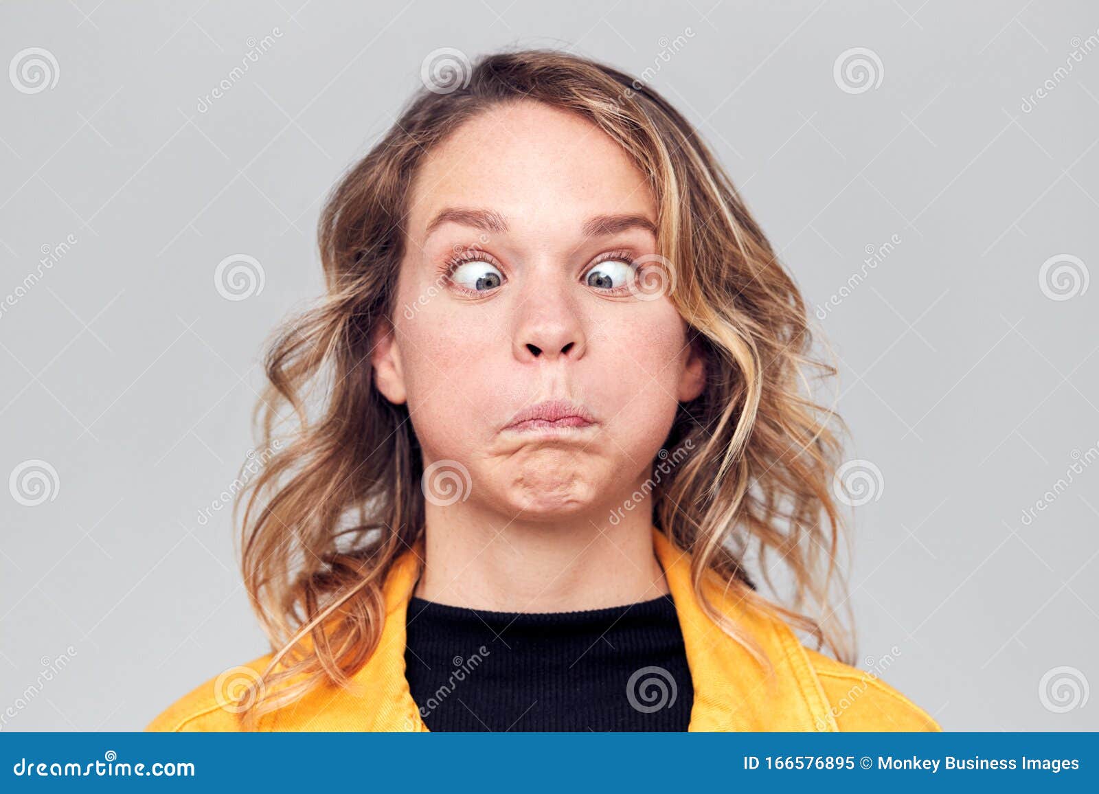 Head and Shoulders Studio Shot of Woman Pulling Faces and Smiling at ...