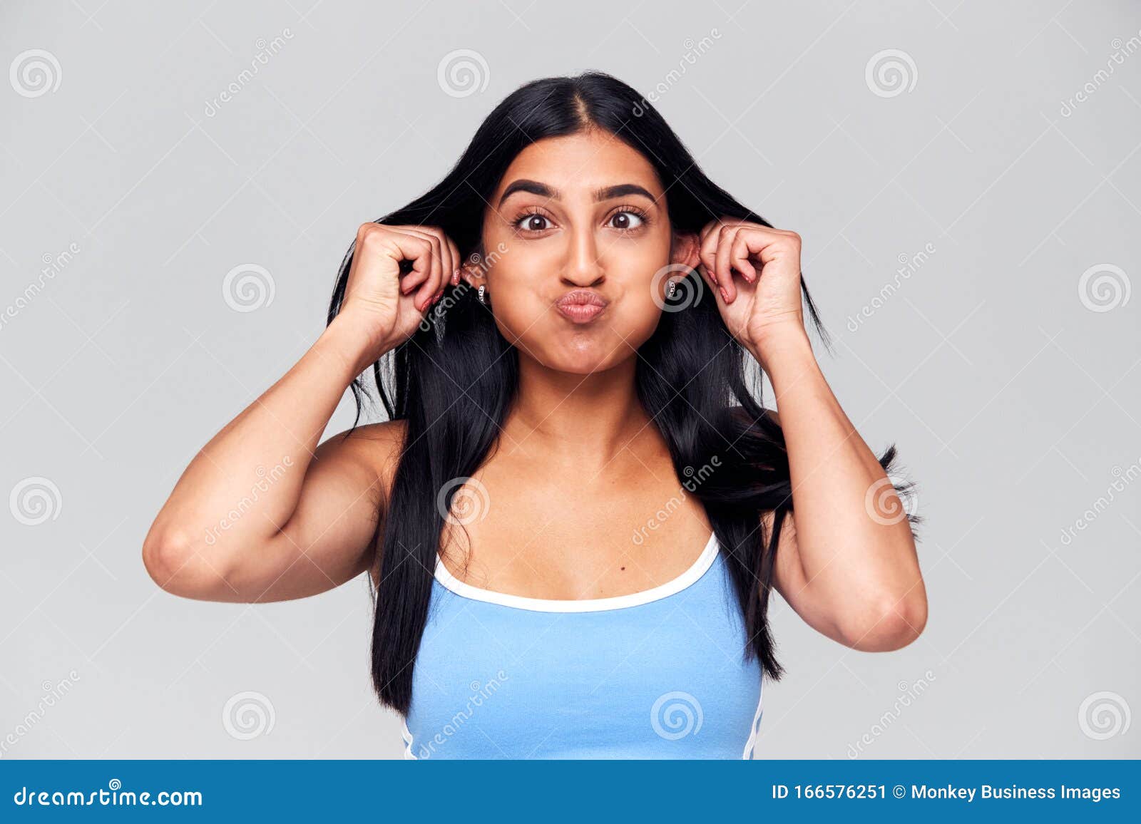 Head and Shoulders Studio Shot of Woman Pulling Faces and Smiling at ...