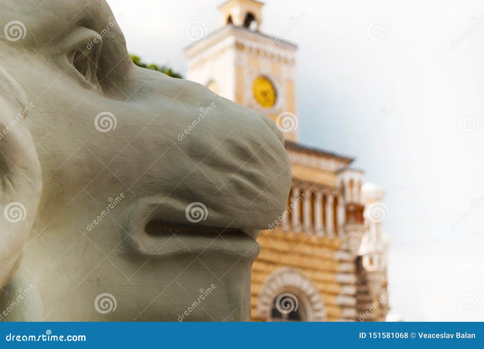 The Head of a Statue of a Lion on the Background of a Historic Building ...