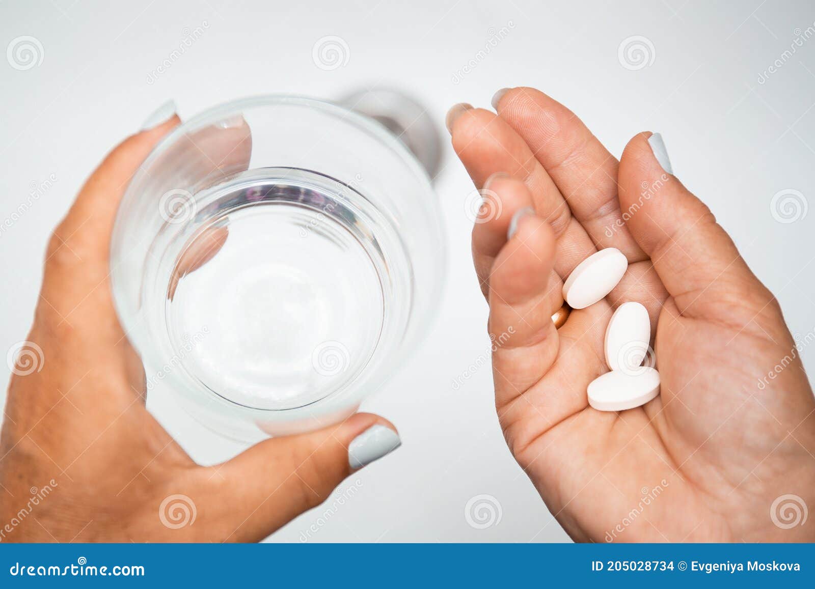 Headache Hand With Pills Medicine Tablets And Glass Of Water Against