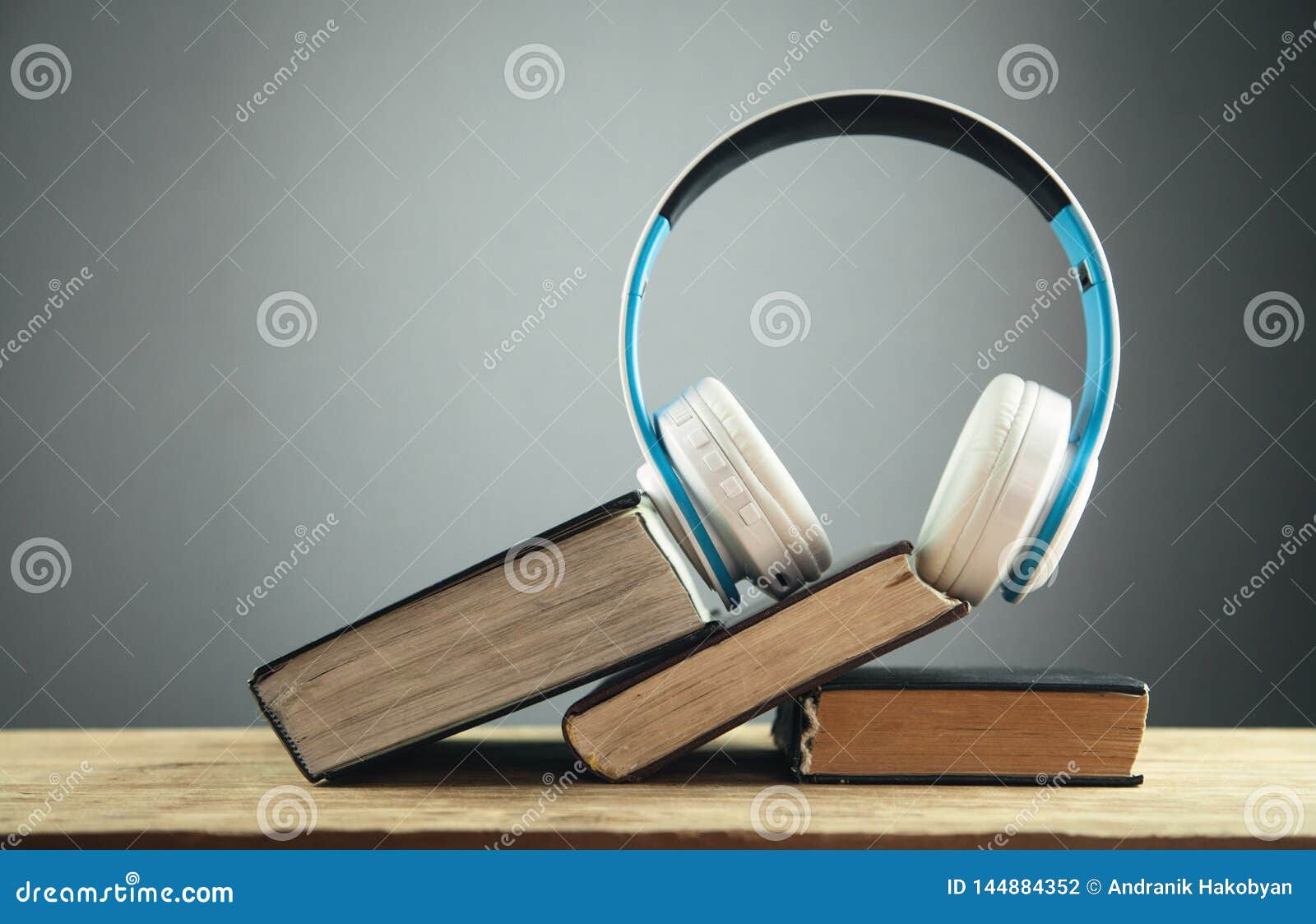 Headphones and Book on Wooden Table. Audio Book Concept Stock Photo ...