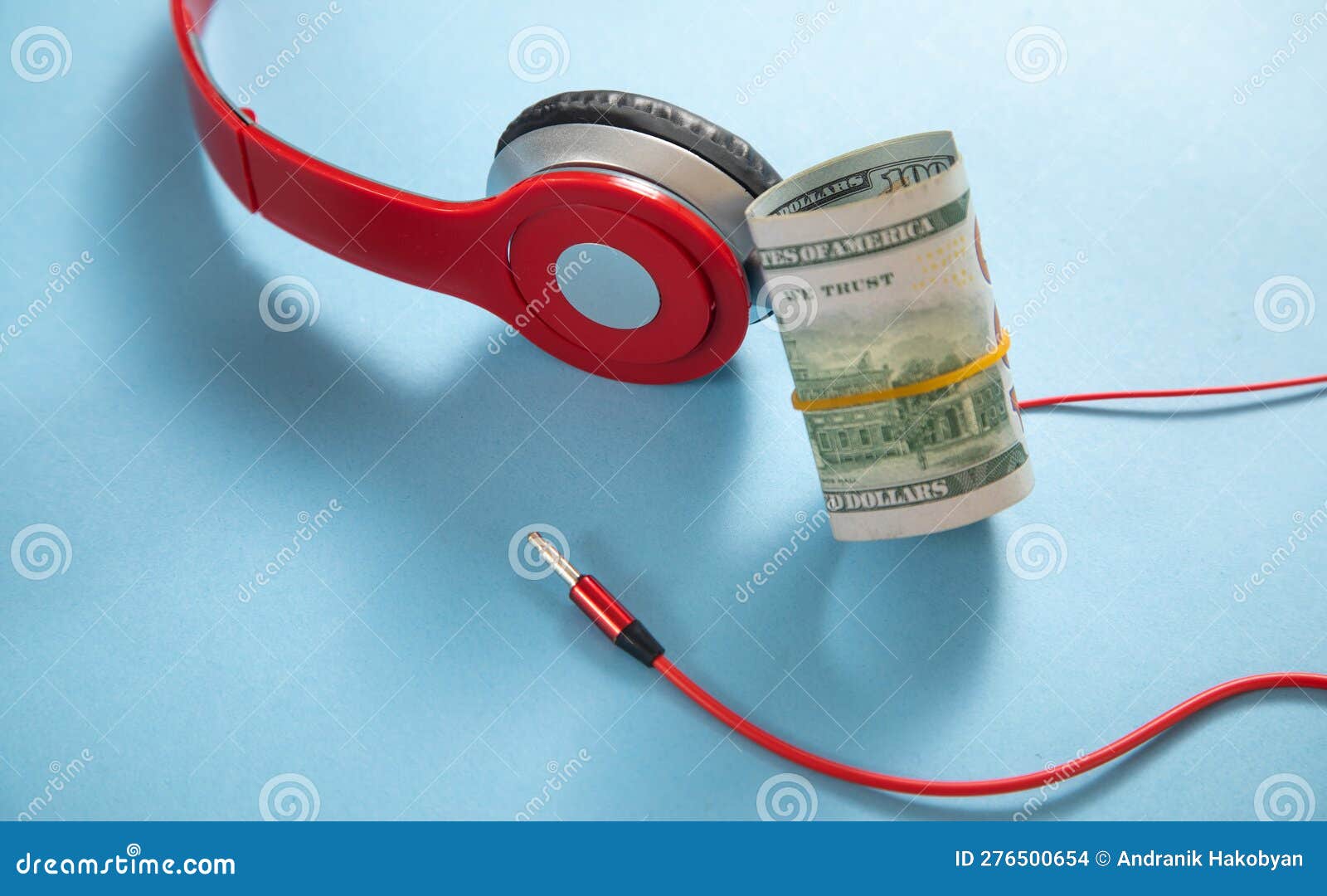 Headphones with a Dollar Money on the Blue Background Stock Photo ...