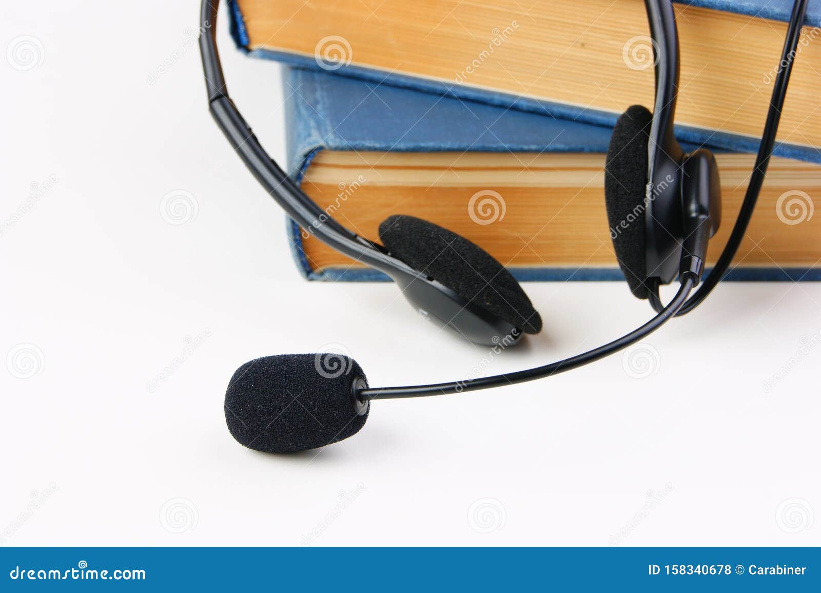 Headphones with a Microphone and a Stack of Books Stock Photo - Image ...