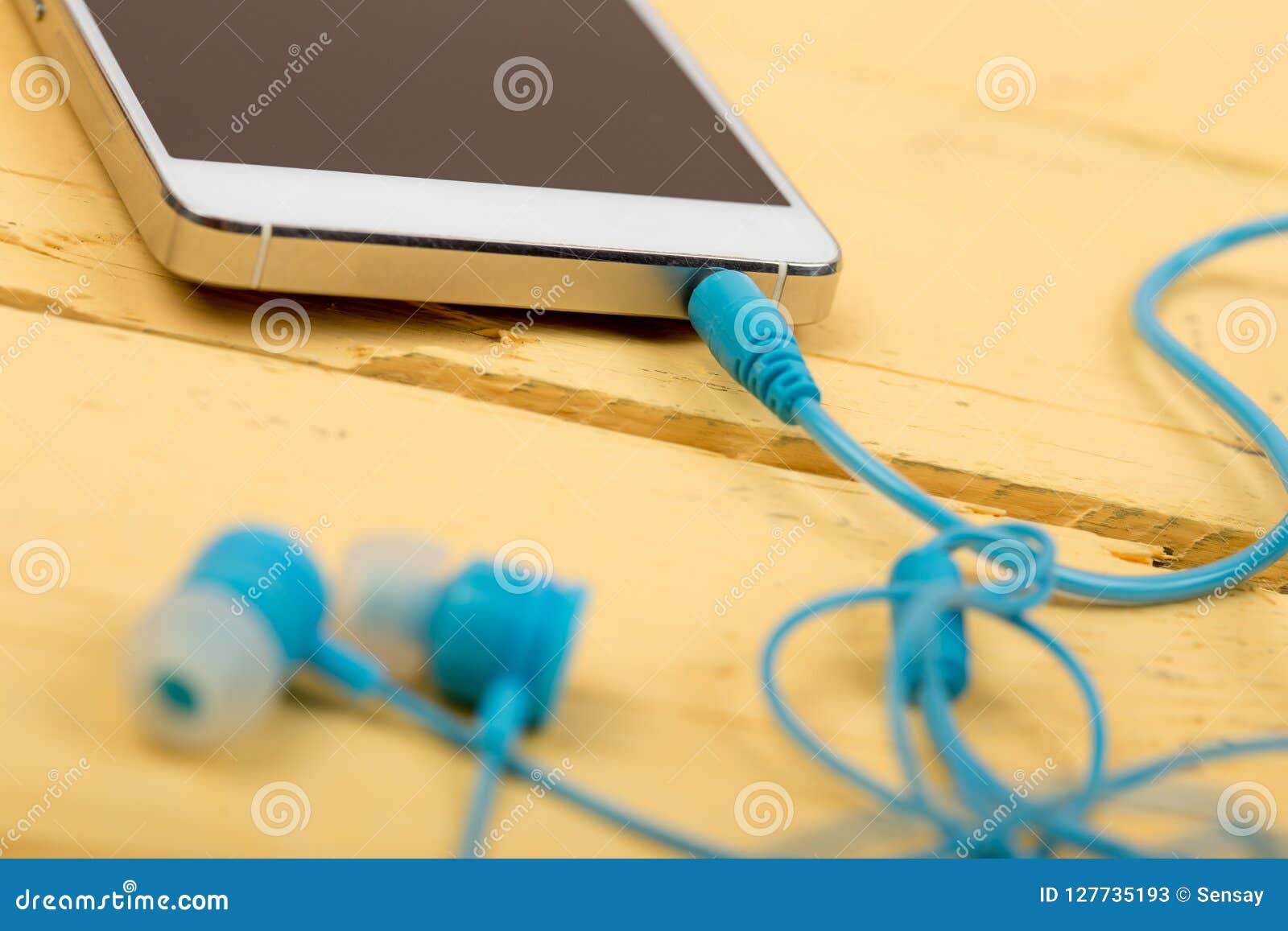 Headphones and Smart Phone on Wooden Table Stock Image - Image of ...