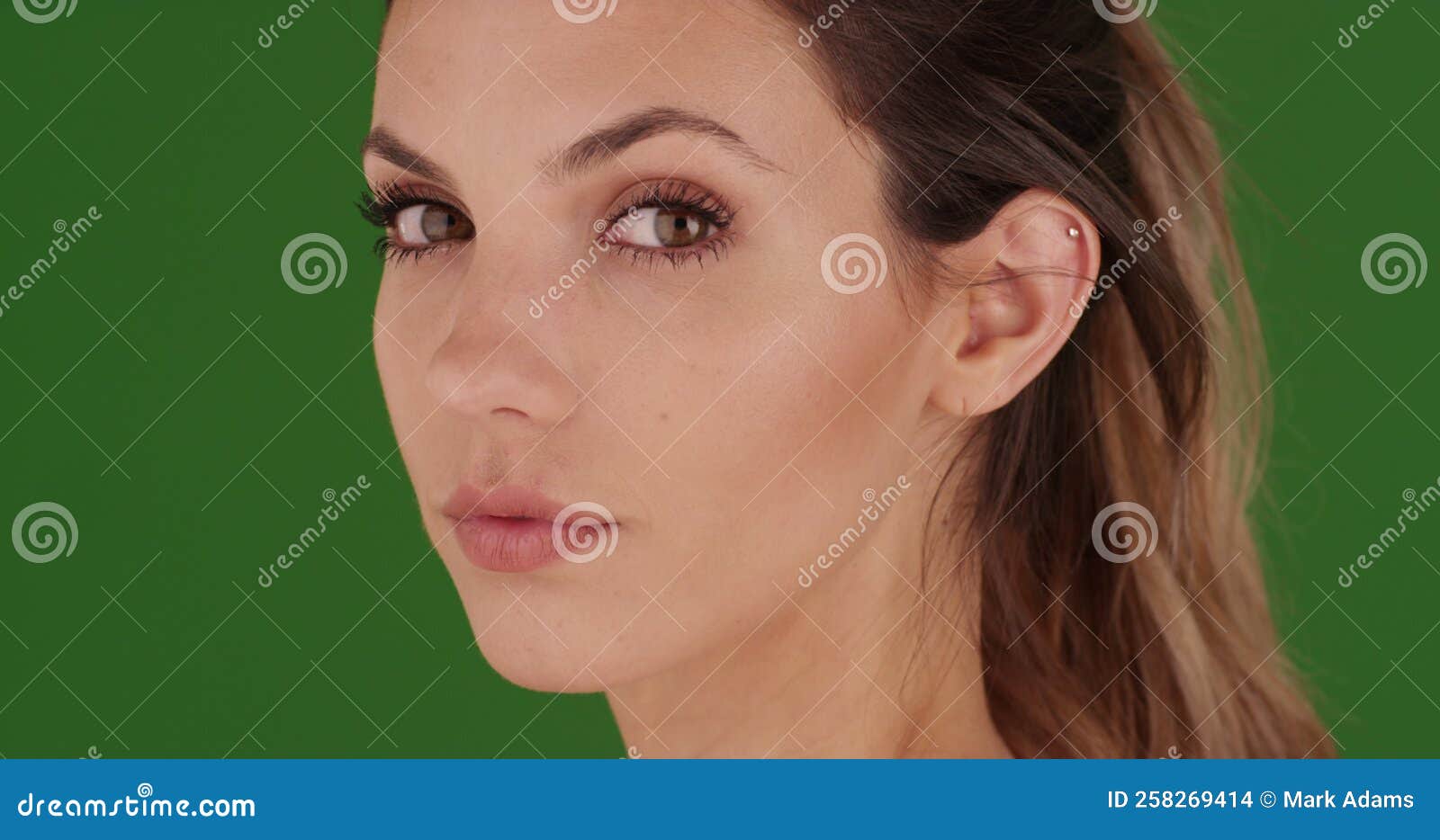 Headshot Of Attractive Young Woman Posing For Camera On Greenscreen
