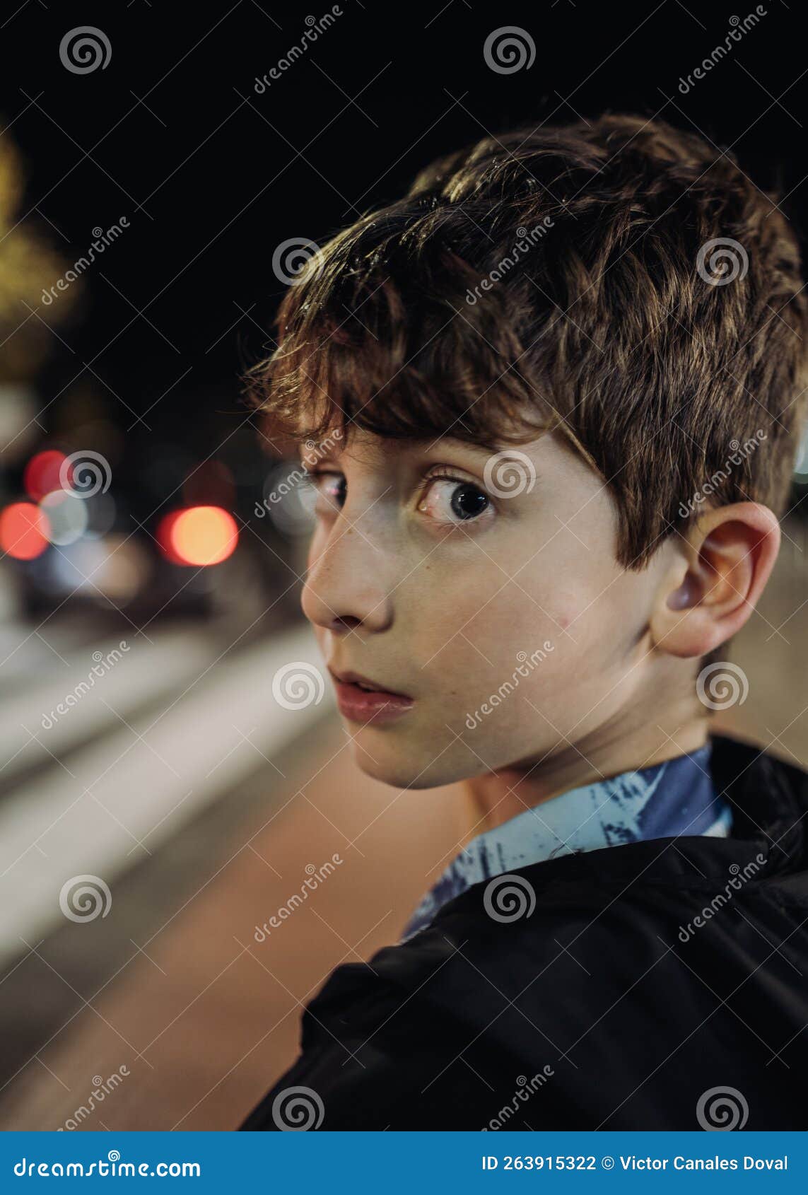 Headshot Portrait of a Young Boy Lost at Night Looking Back Scared ...
