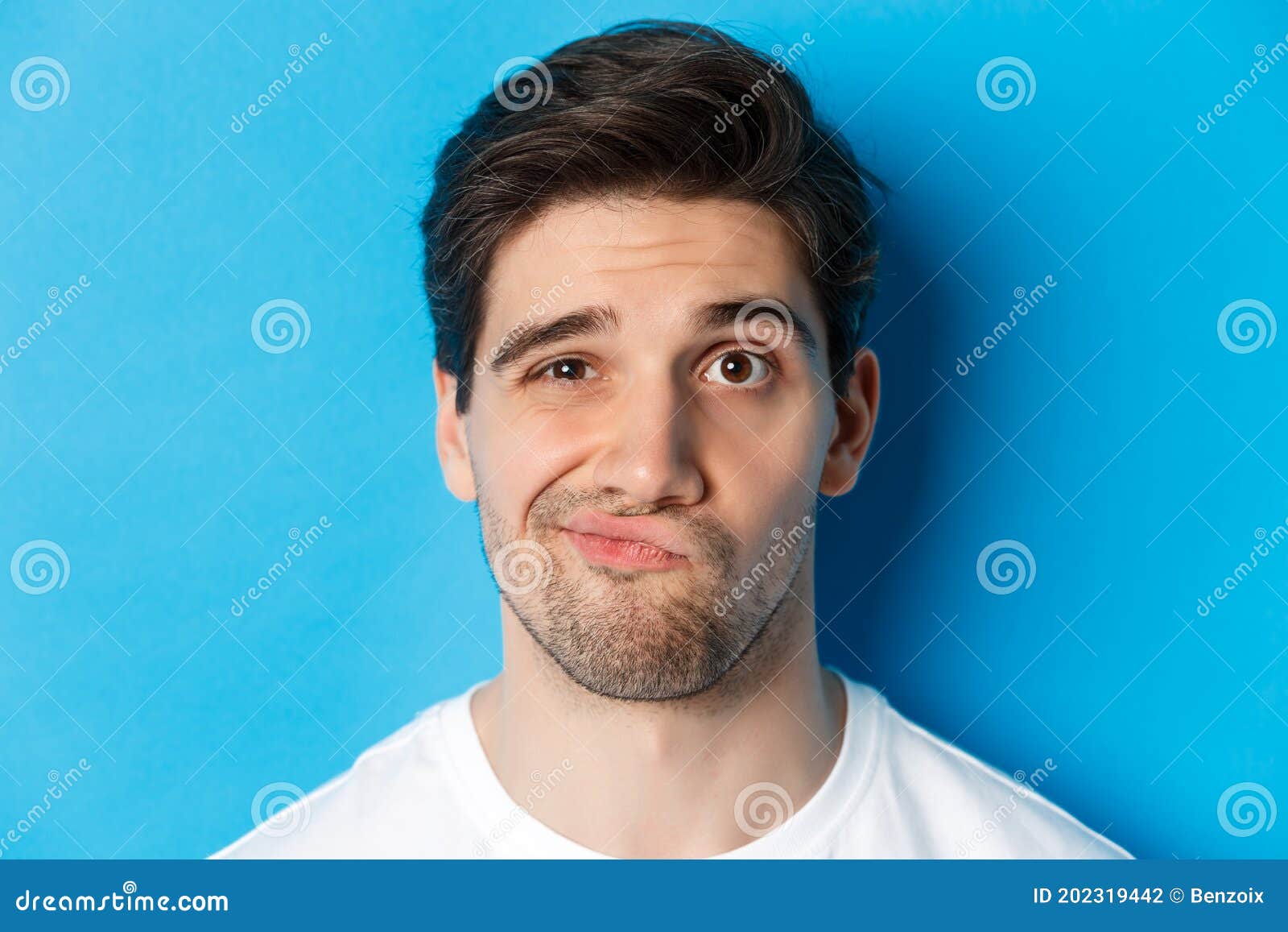 Headshot of Skeptical Guy Looking at Something Unamusing, Grimacing and ...