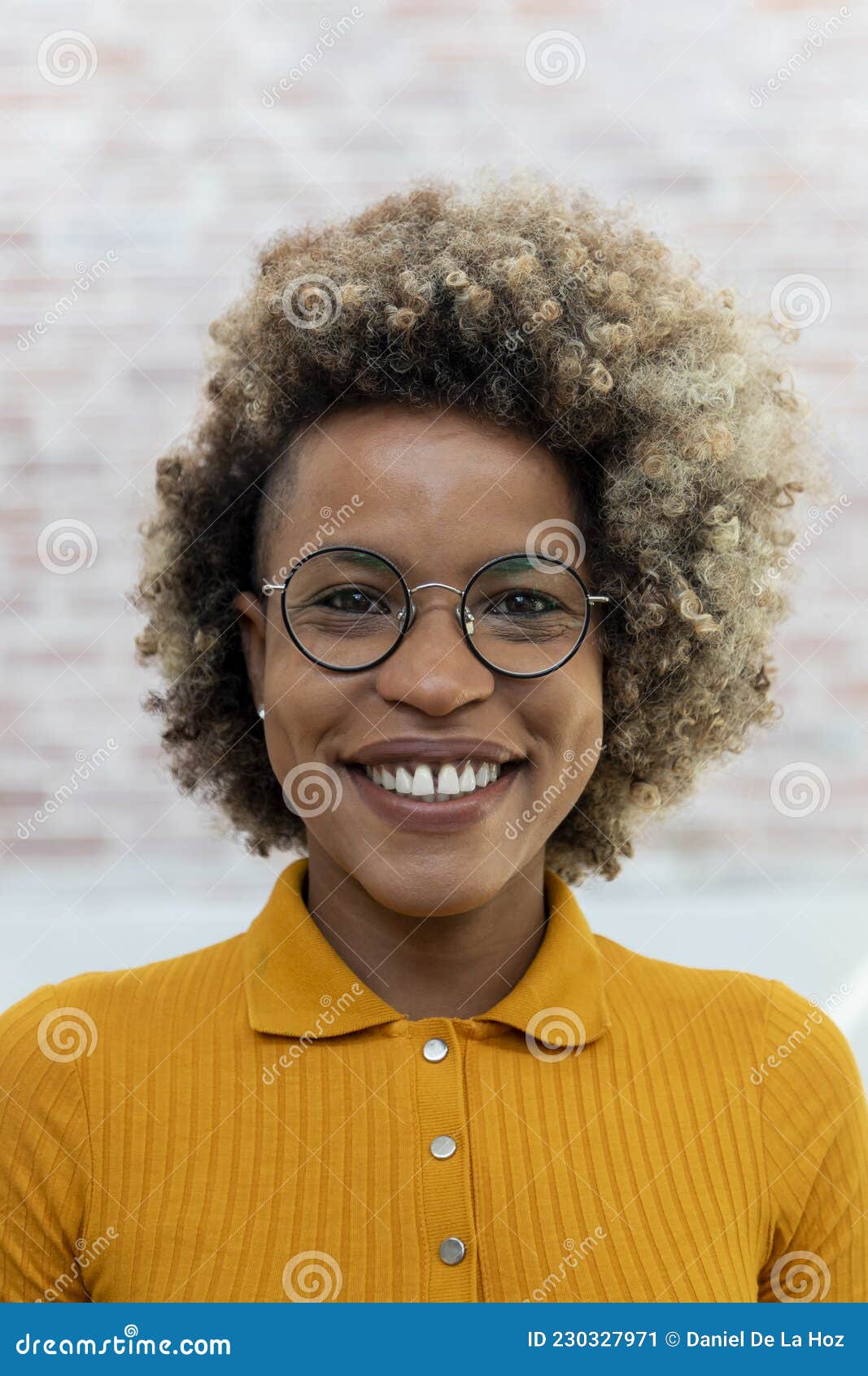 Headshot Of Smiling Young African American Woman With Blond Afro Hair