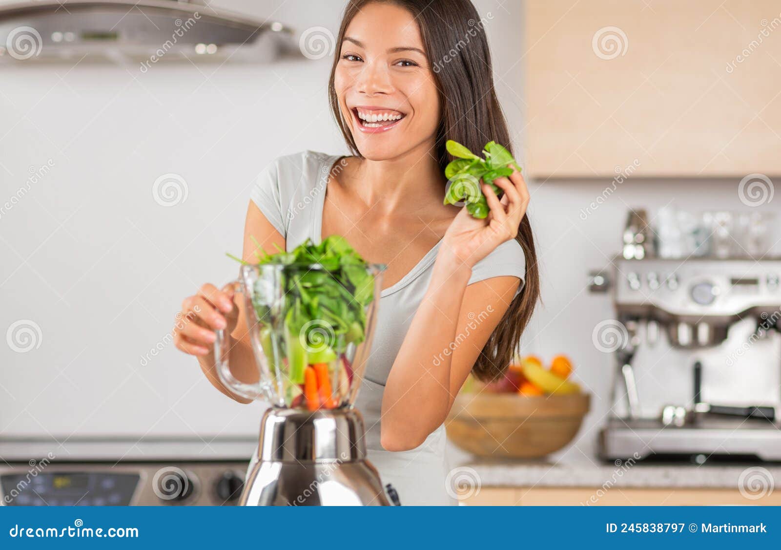 Healthy Green Smoothie Asian Woman Using Spinach In Blender To Make