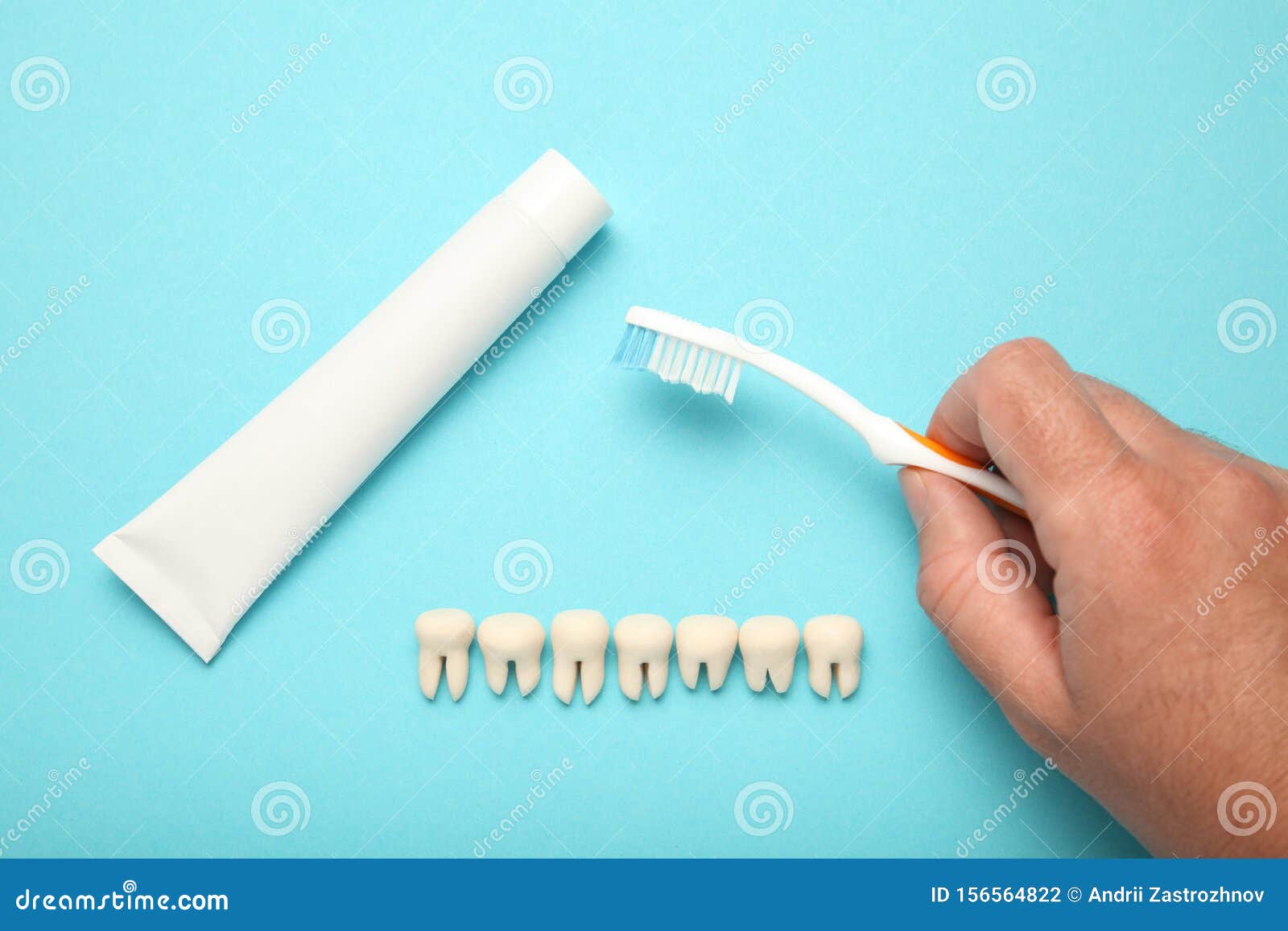 Healthy White Teeth, Toothpaste and Hand Hold Toothbrush on Blue ...