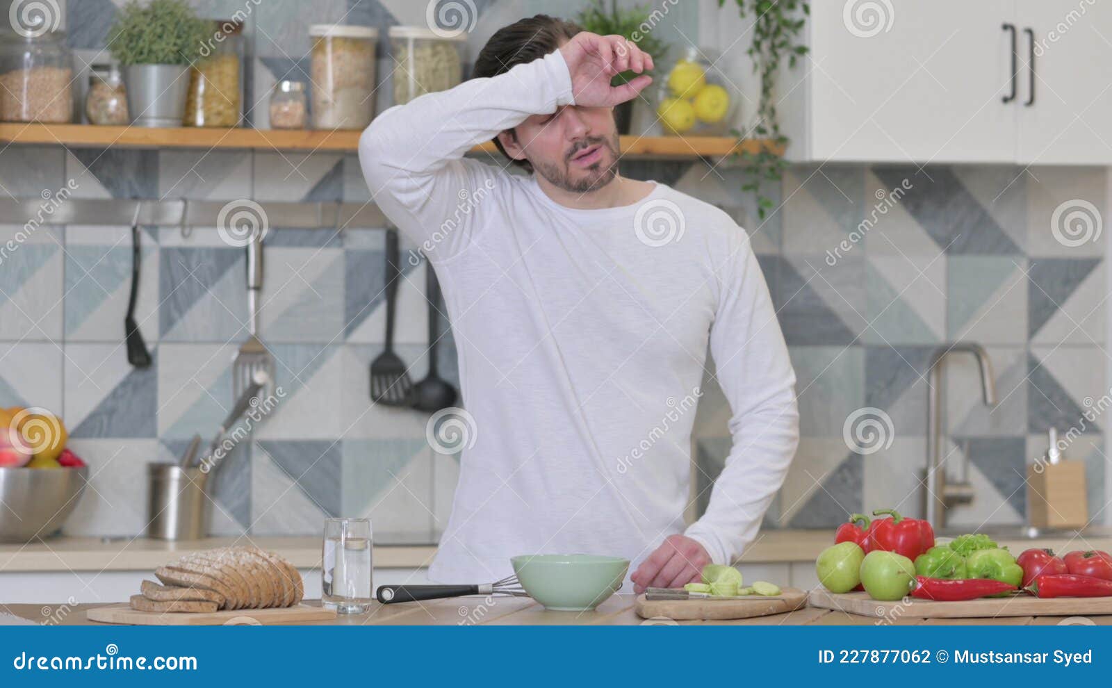 Healthy Young Man Feeling Tired while Cooking in Kitchen Stock Photo ...