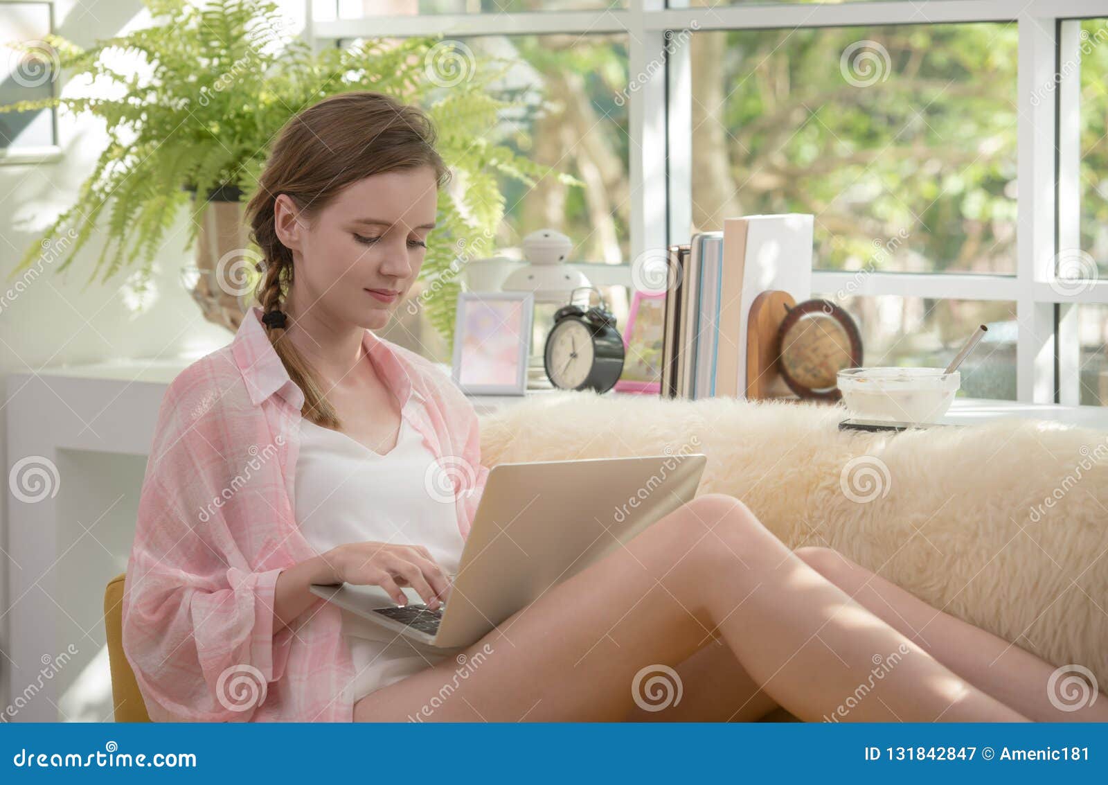 Healthy Young Woman Sitting on a Couch Using Laptop Computer Looking ...