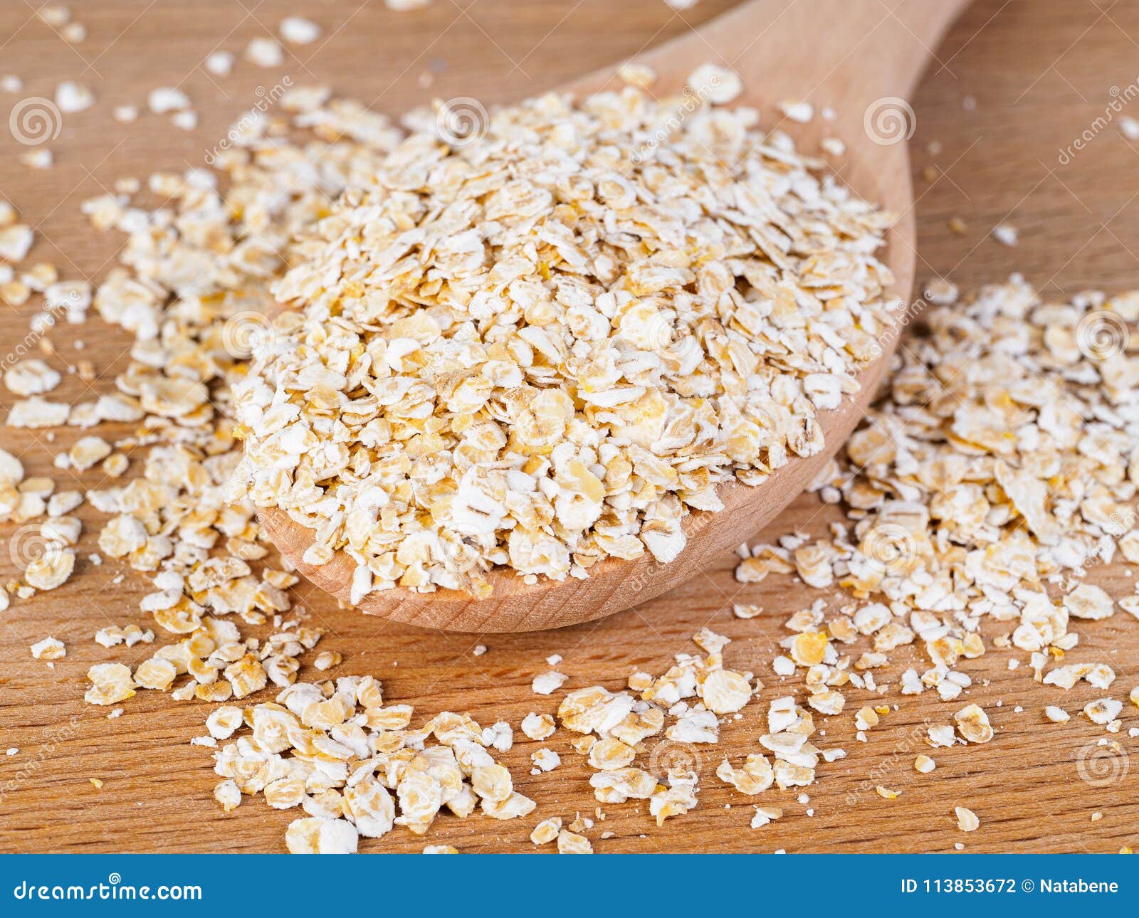 Heap of Oatmeal in Wooden Spoon on Wooden Background, Side View Stock ...