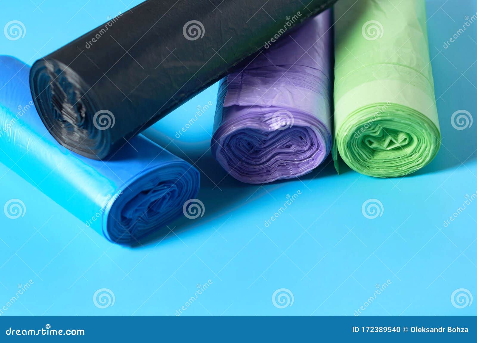 Heap of Rolls of Disposable Plastic Garbage Bag on Blue Background ...