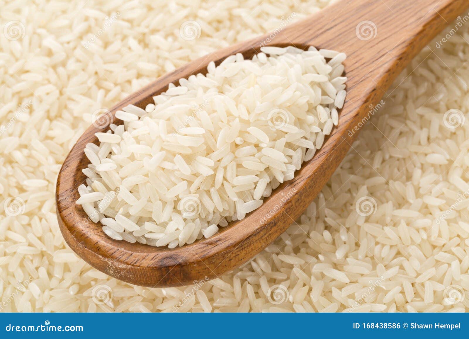 Heap of White Uncooked, Raw Long Grain Rice in Wooden Spoon on Rice ...