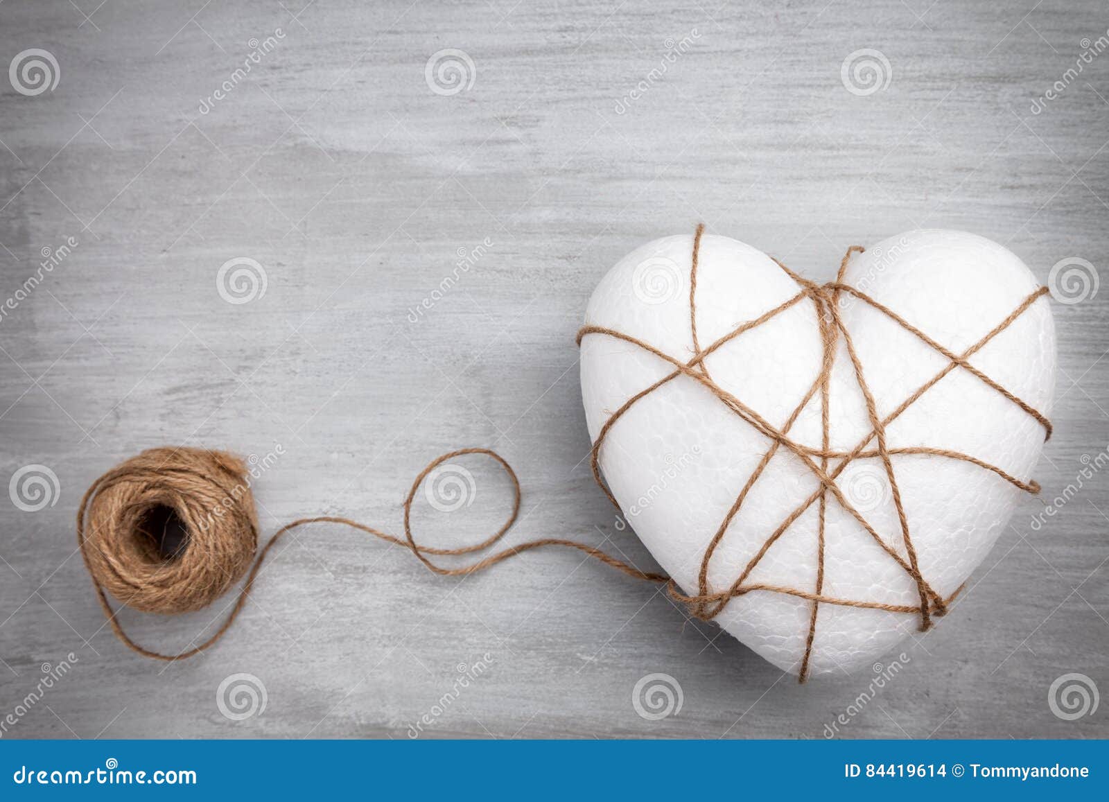 Heart Bound by a String on Grey Background Stock Photo - Image of ...