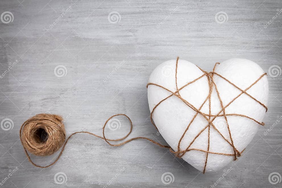 Heart Bound by a String on Grey Background Stock Photo - Image of ...