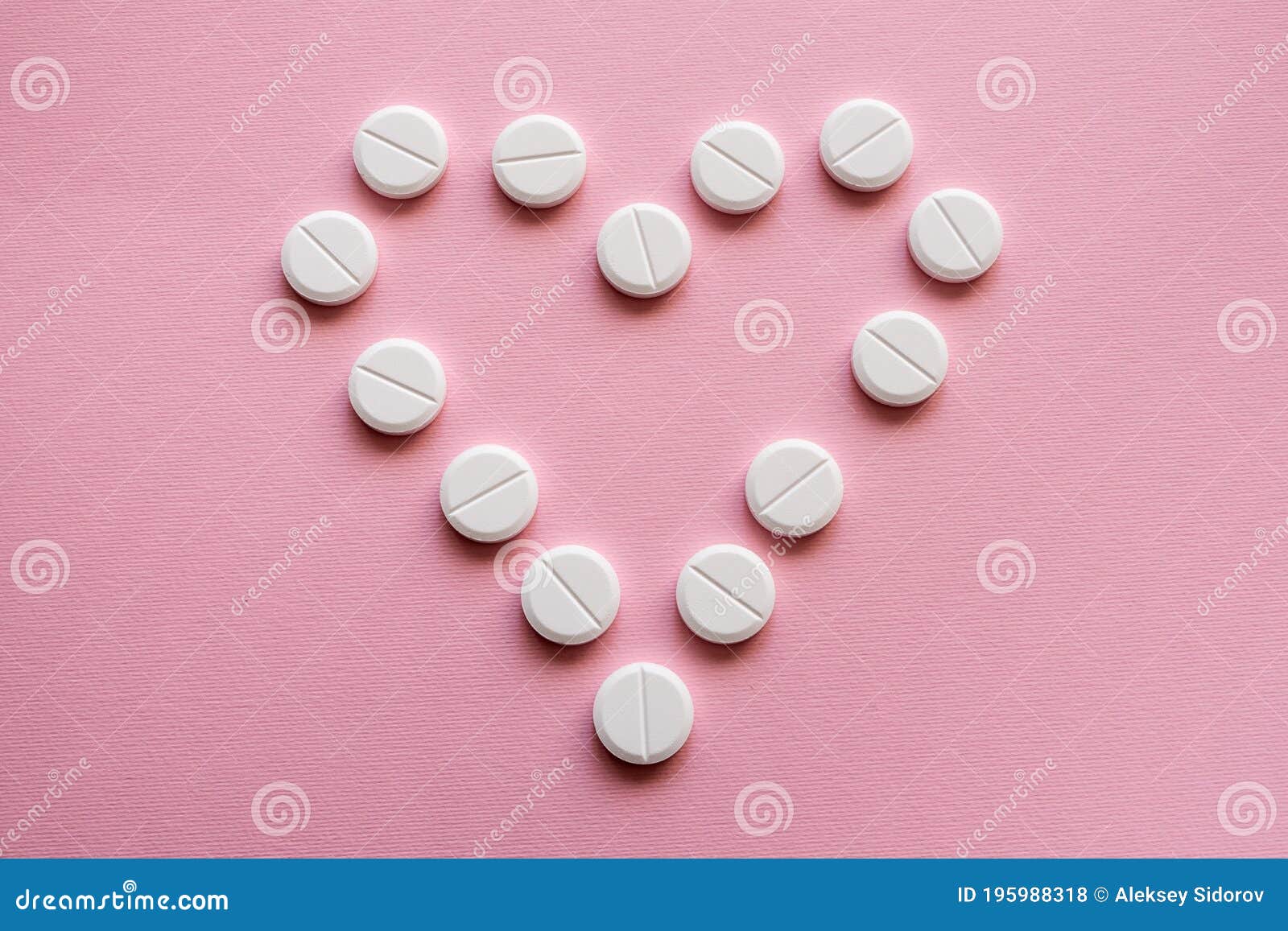 Heart Made of Medicine Tablets on a Pink Background. Isolated Stock ...