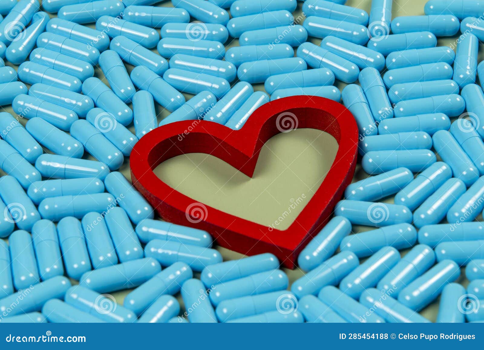 Heart Shape and Blue Capsules. Importance of Medication Treatment Stock ...