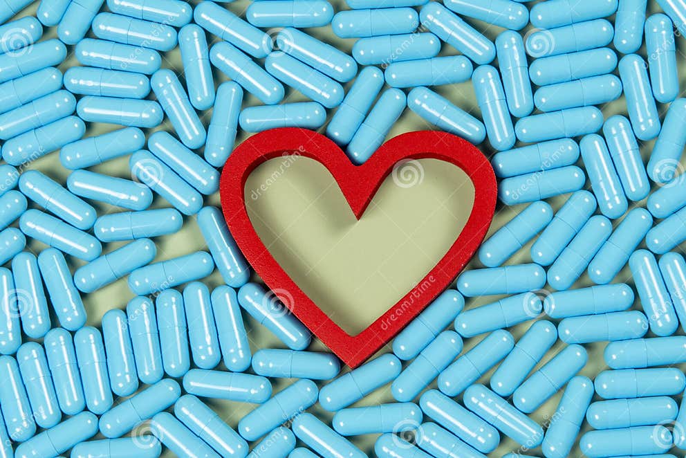 Heart Shape and Blue Capsules. Importance of Medication Treatment Stock ...