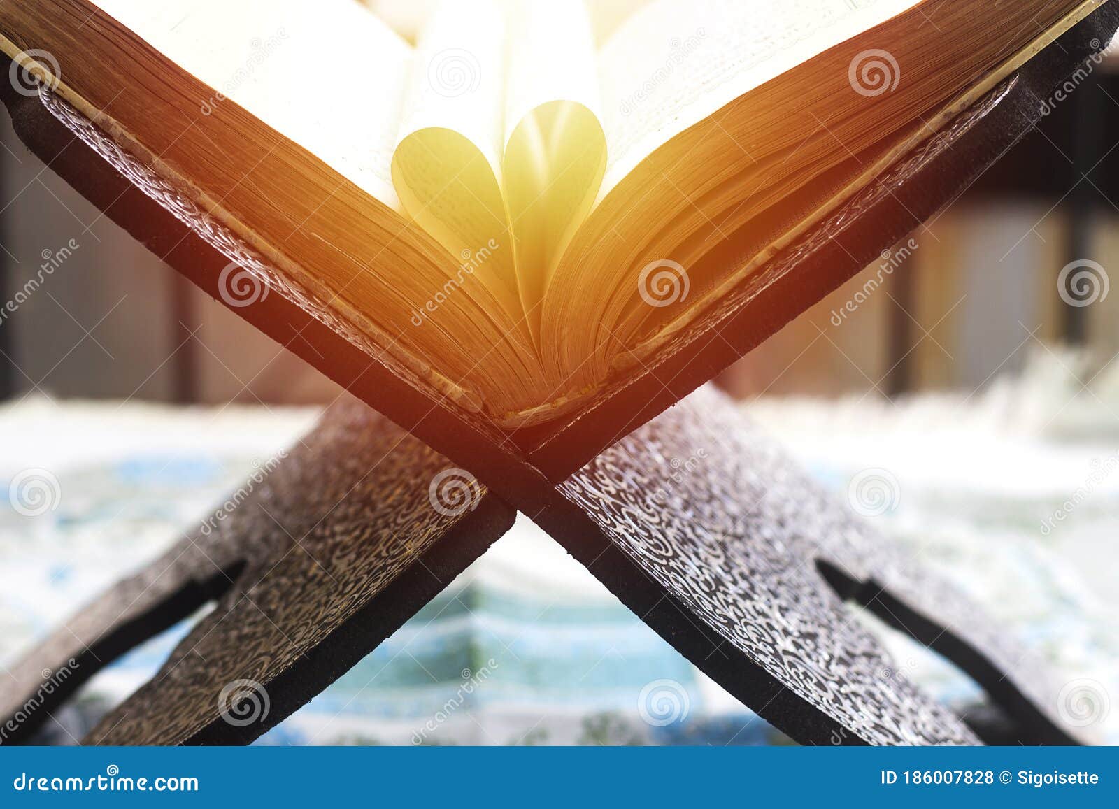 Heart Shape from Holy Quran Book on Stand with Sun Effect. Stock Photo ...