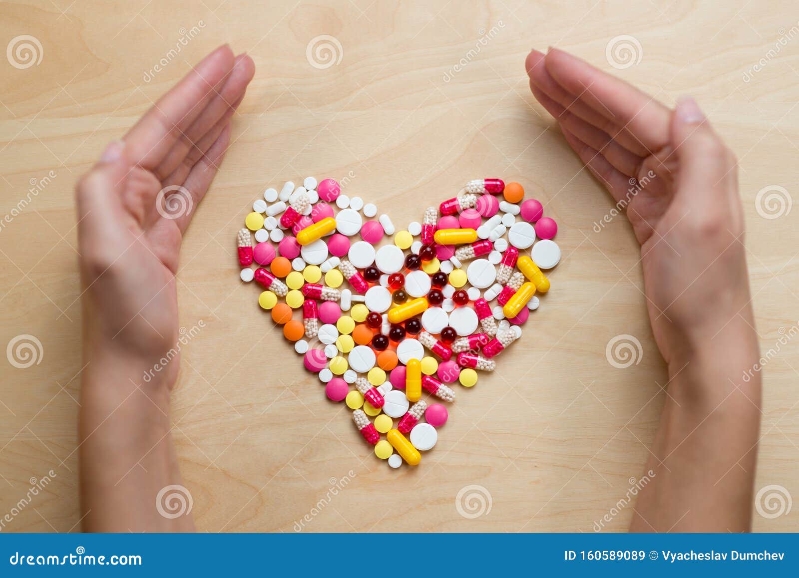 A Heart Shape Laid Out of Multi-colored Tablets on a Table, Covered ...